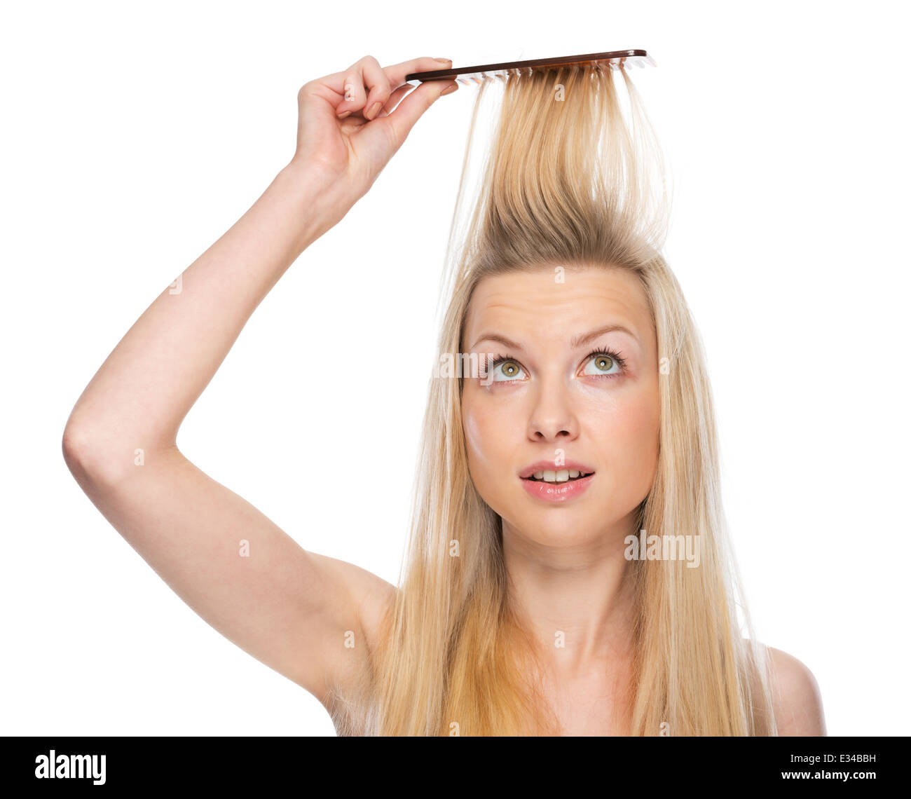 Young woman combing hair Stock Photo - Alamy