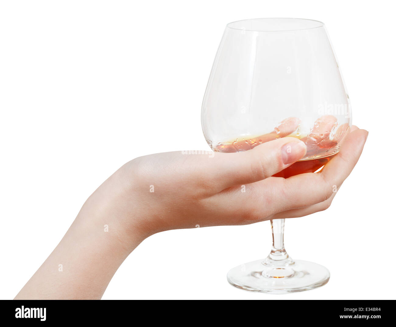 glass goblet with brandy in hand isolated on white background Stock ...