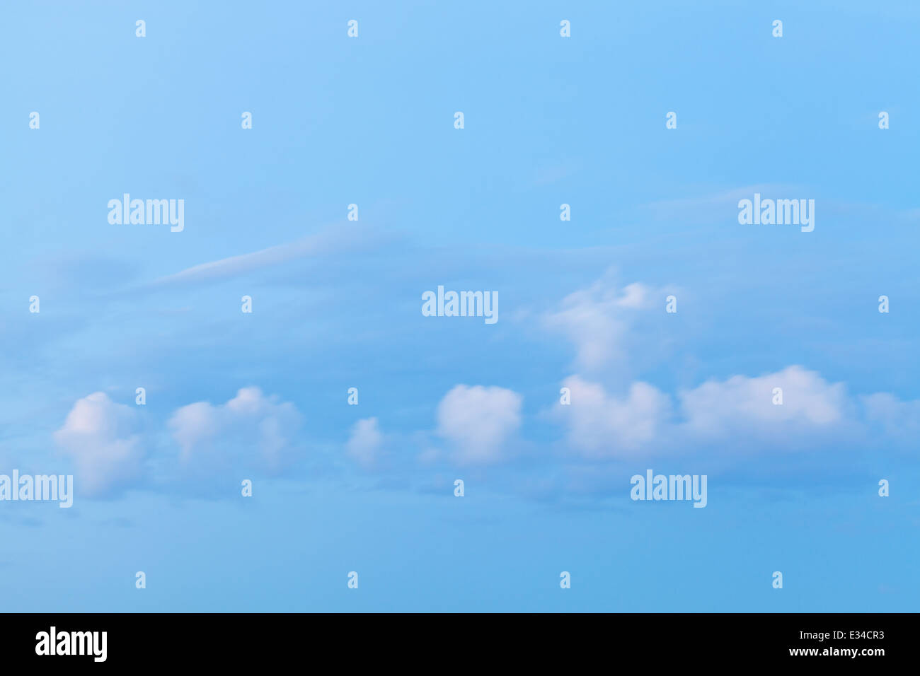 little white clouds in blue dusk sky in summer evening Stock Photo - Alamy