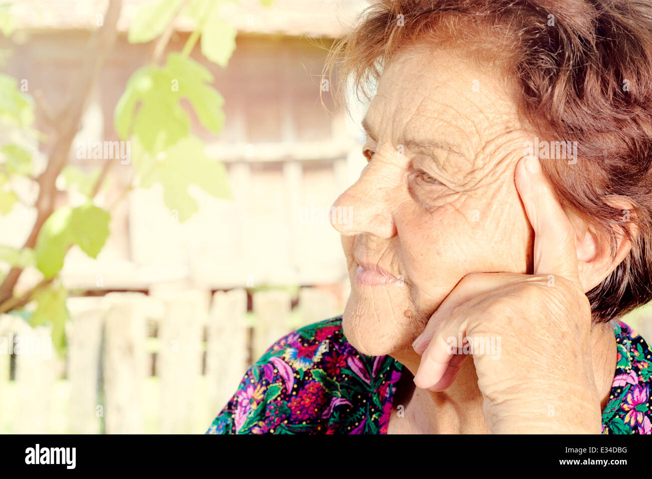 Portrait of worried old woman in backyard Stock Photo - Alamy