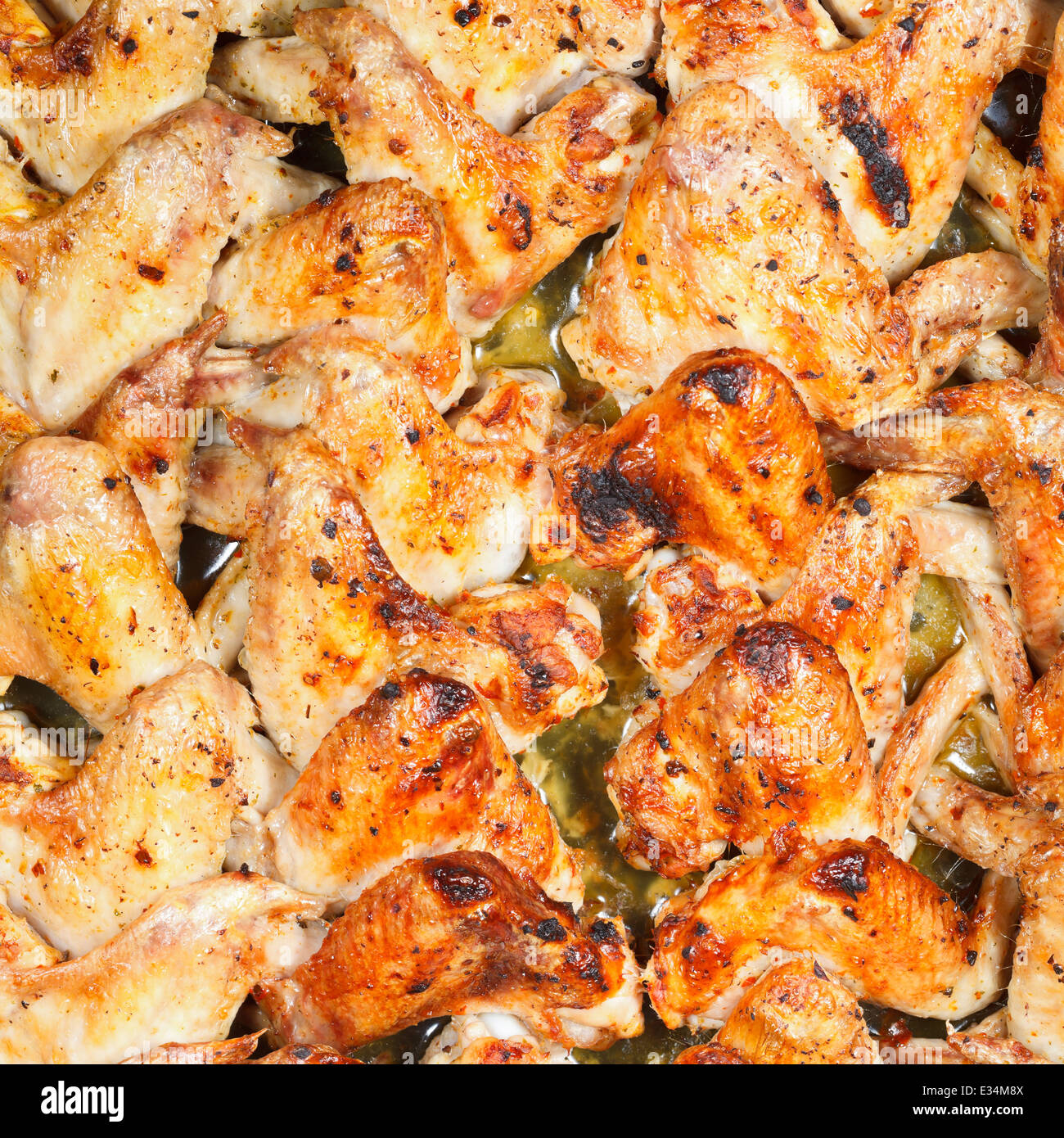 above view of many roasted spicy chicken wings on hot tray Stock Photo ...