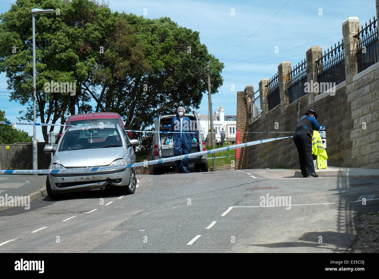 Police forensic investigation of an abandoned car in relation to a ...