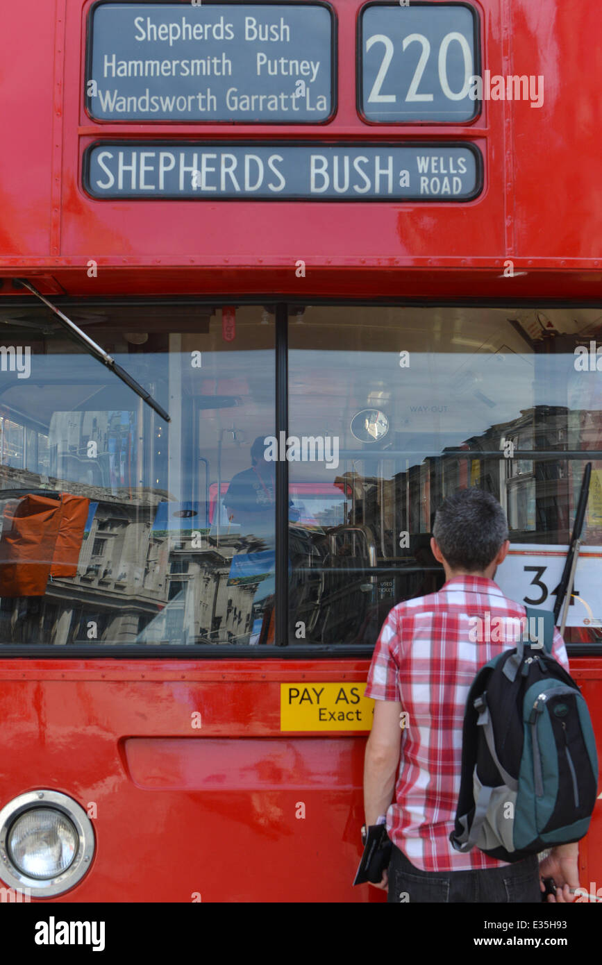 Regent Street, London, UK. 22nd June 2014. A man looks inside a bus at ...
