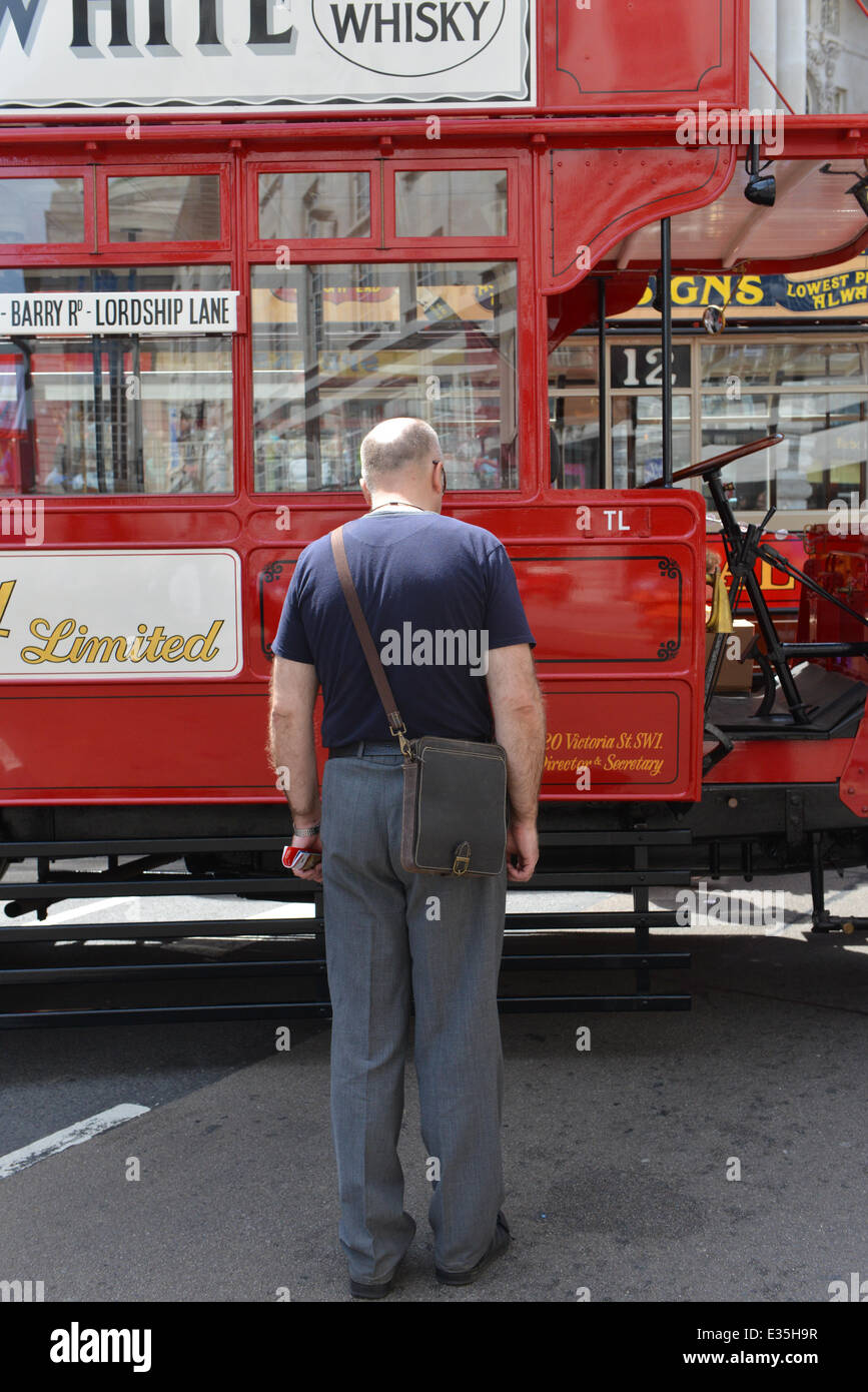 Regent Street, London, UK. 22nd June 2014. A man looks inside a bus at ...