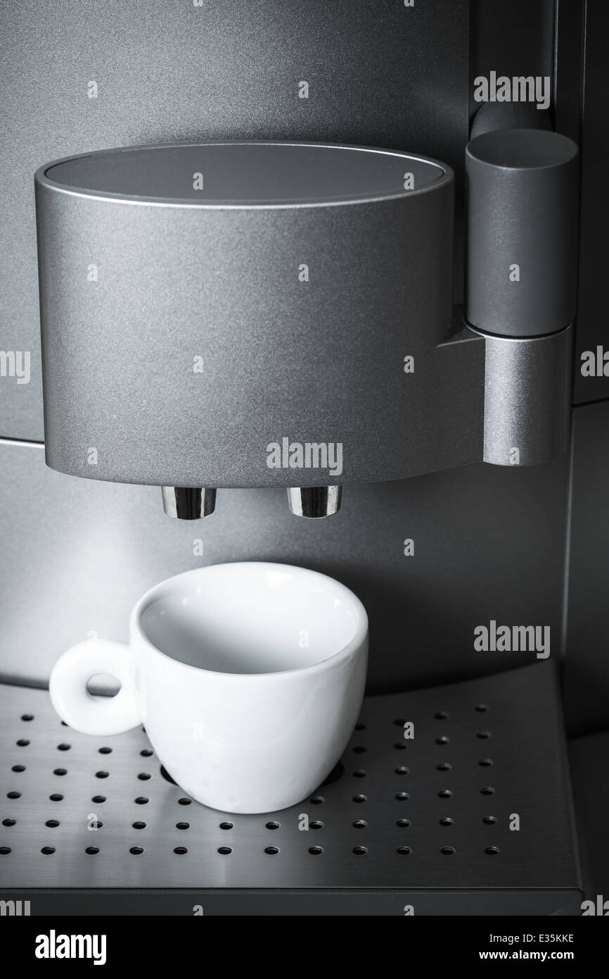 White ceramic cup stands in modern coffee machine Stock Photo - Alamy