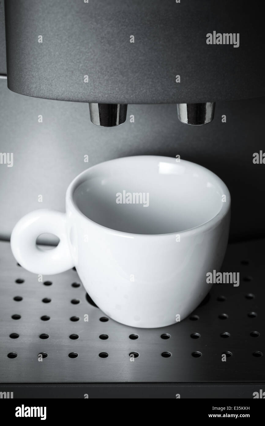 White ceramic cup stands in modern automatic coffee machine Stock Photo ...