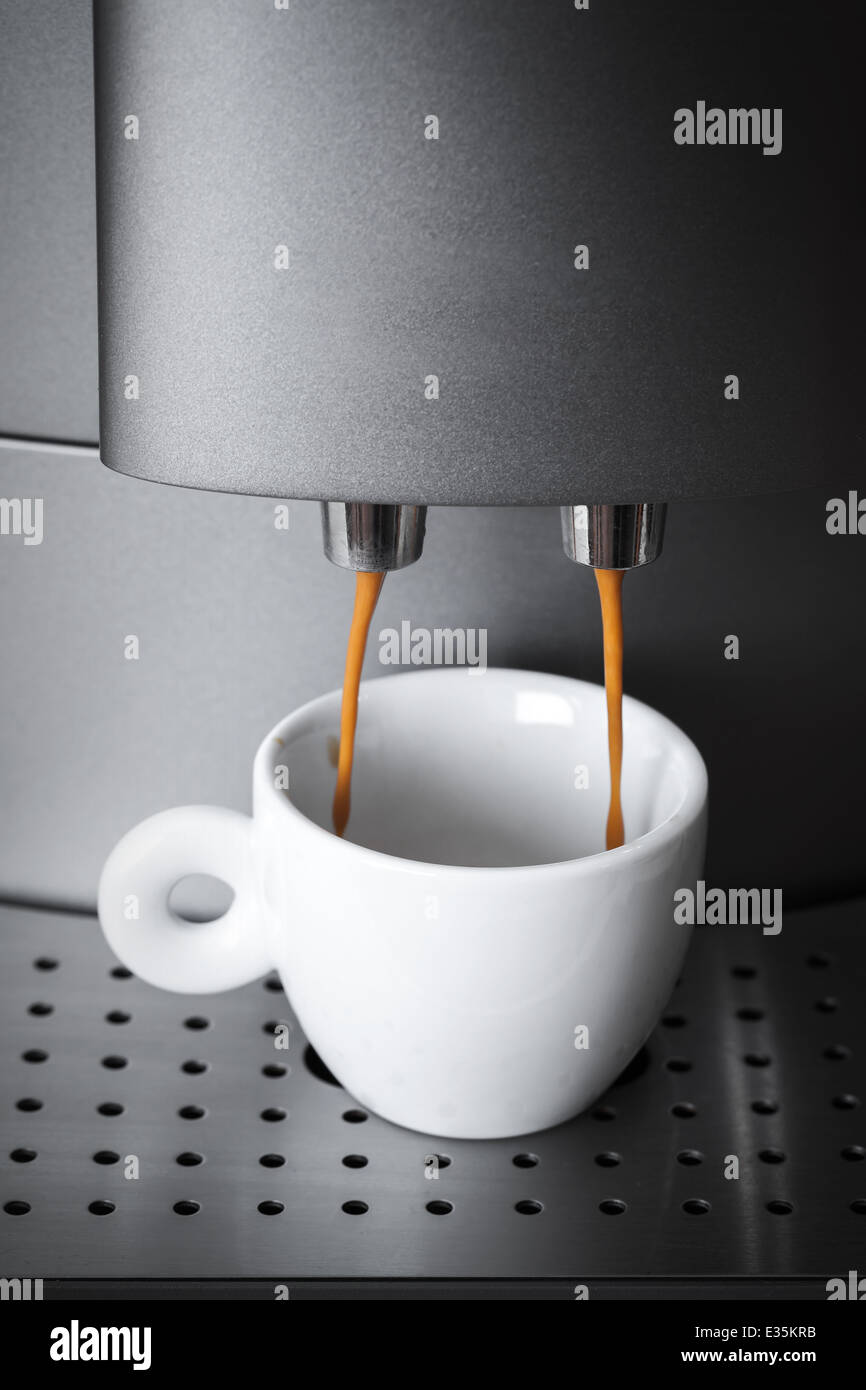 White ceramic cup in coffee machine, espresso preparing Stock Photo - Alamy
