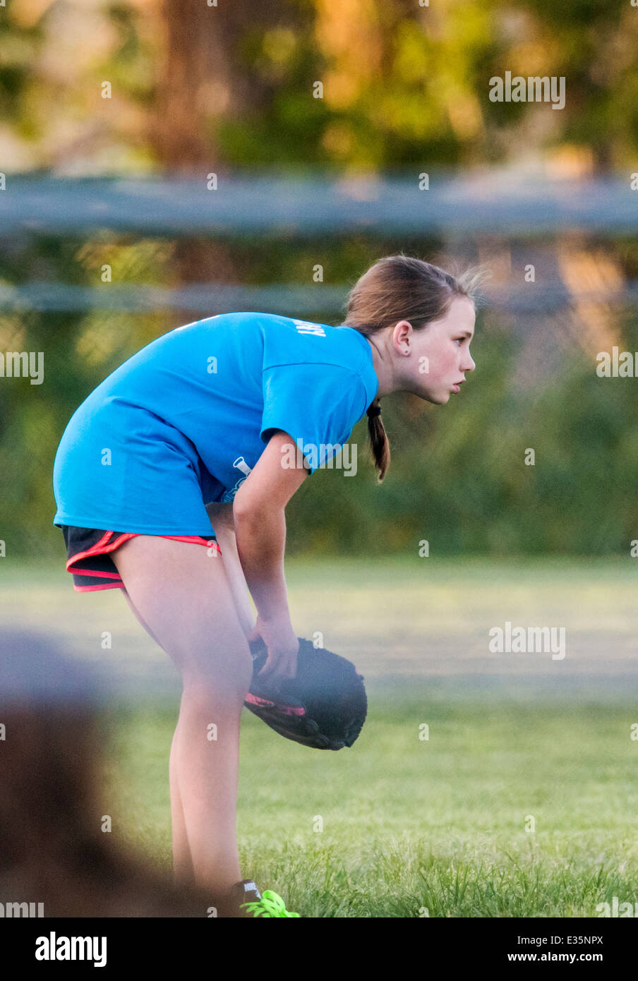 Teenage girl playing softball on a clear warm summer evening Stock ...