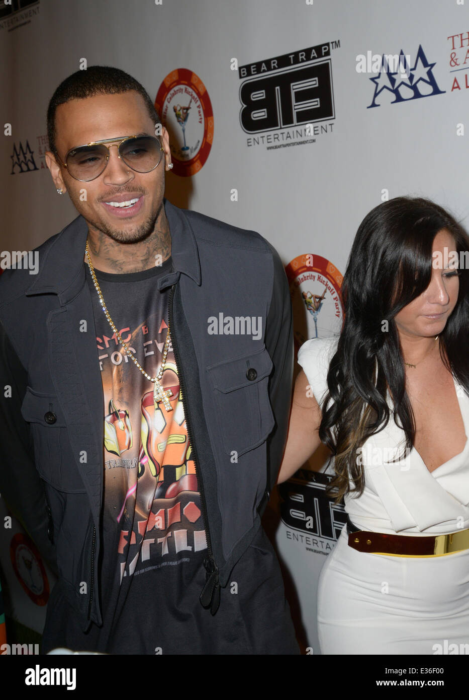 Chris Brown and a female friend walk the red carpet at the All-Star ...