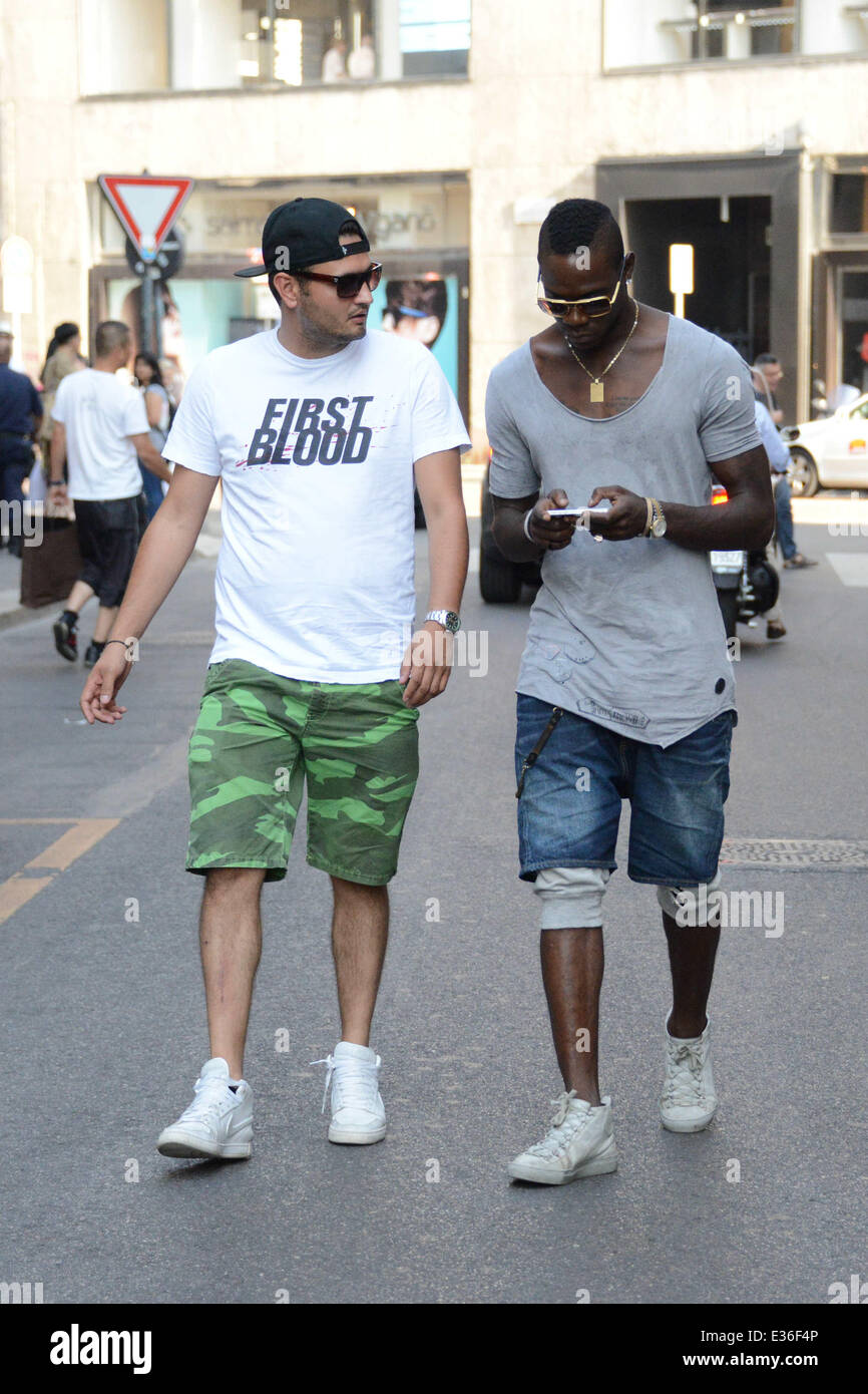 Italian football star Mario Balotelli and a friend return to their ...