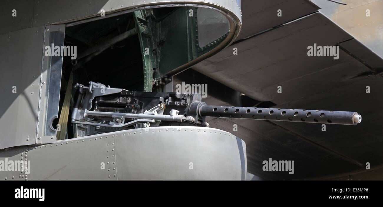A Browning .50 caliber machine gun pointing out of the tail of a WWII ...