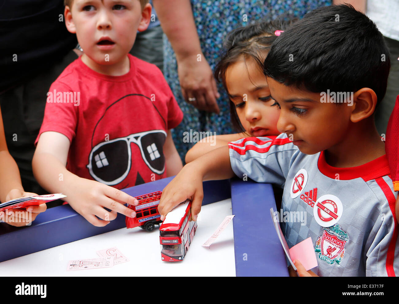 London, Britain. 22nd June, 2014. Children play with bus models during ...