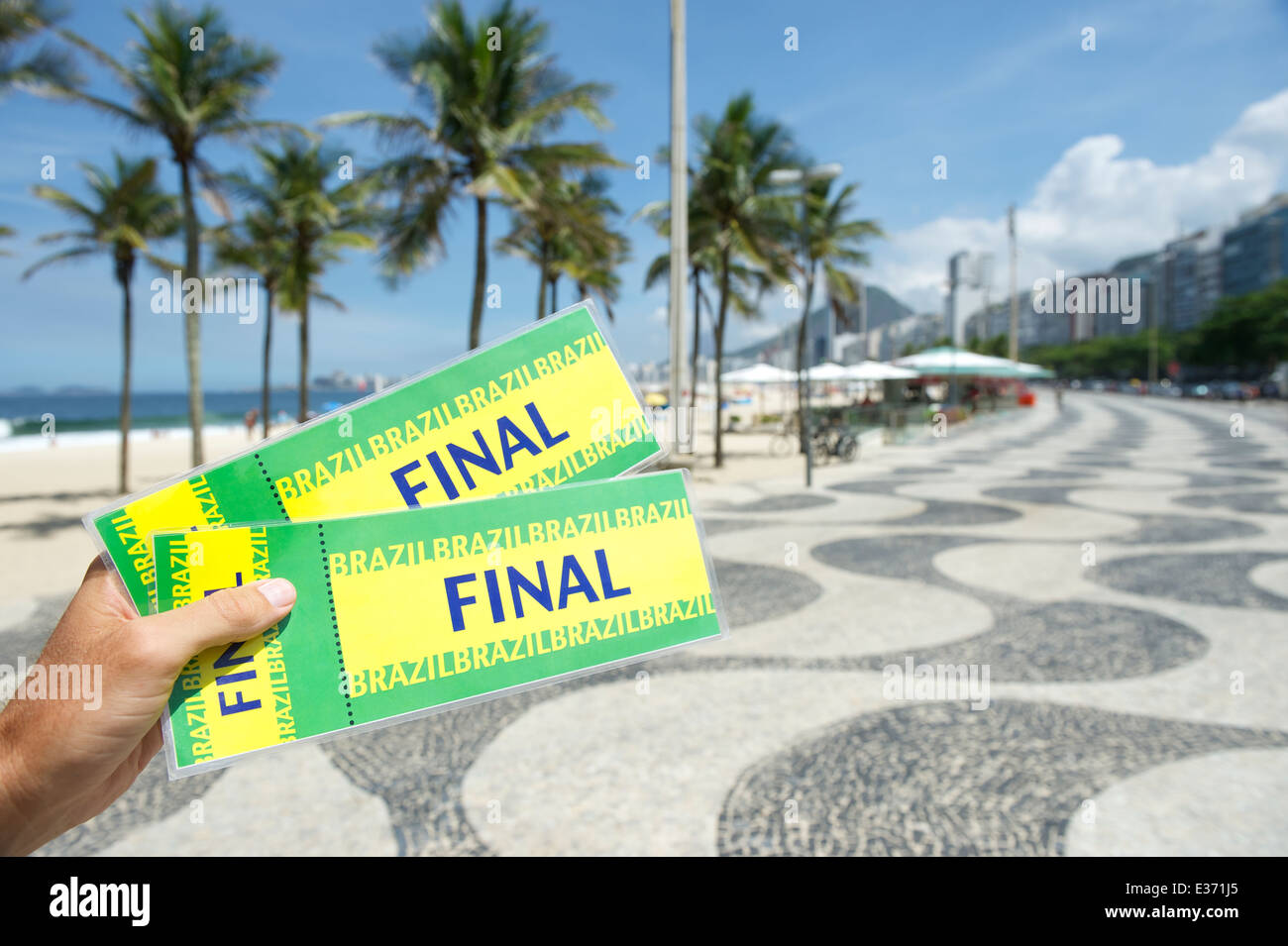 Hand holding two Brazil final tickets to football soccer event in ...
