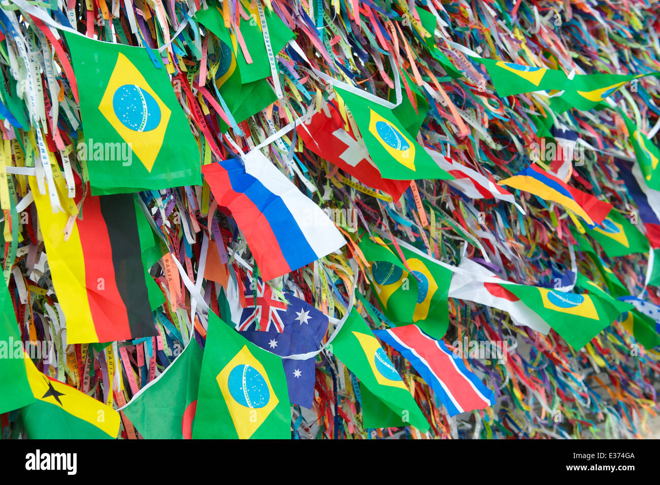 Brazilian and international flags flying on a wall of wish ribbons ...