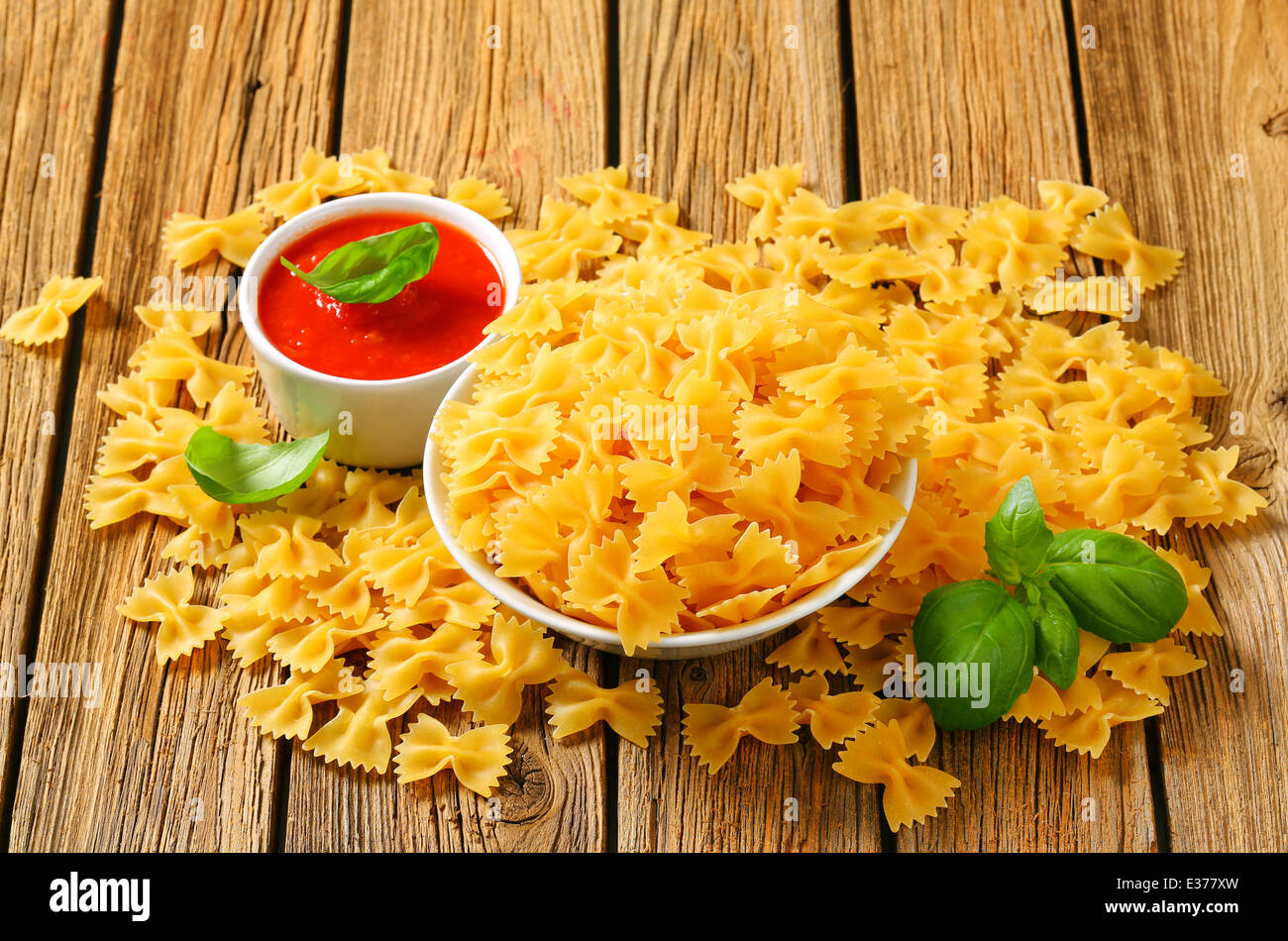 Uncooked bow tie pasta and tomato puree Stock Photo - Alamy