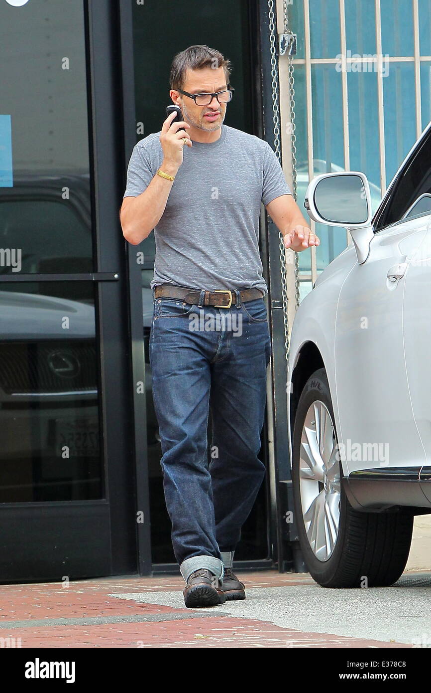 Olivier Martinez seen on his cell phone as he returns to his car ...