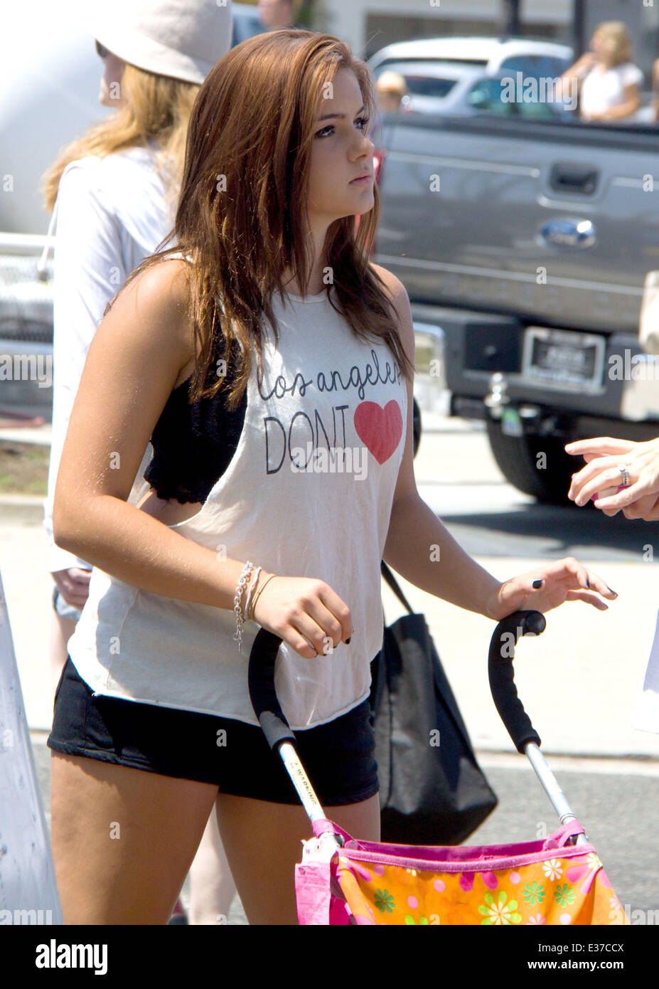Ariel Winter takes a break to sit down in a stroller, as she enjoys a ...