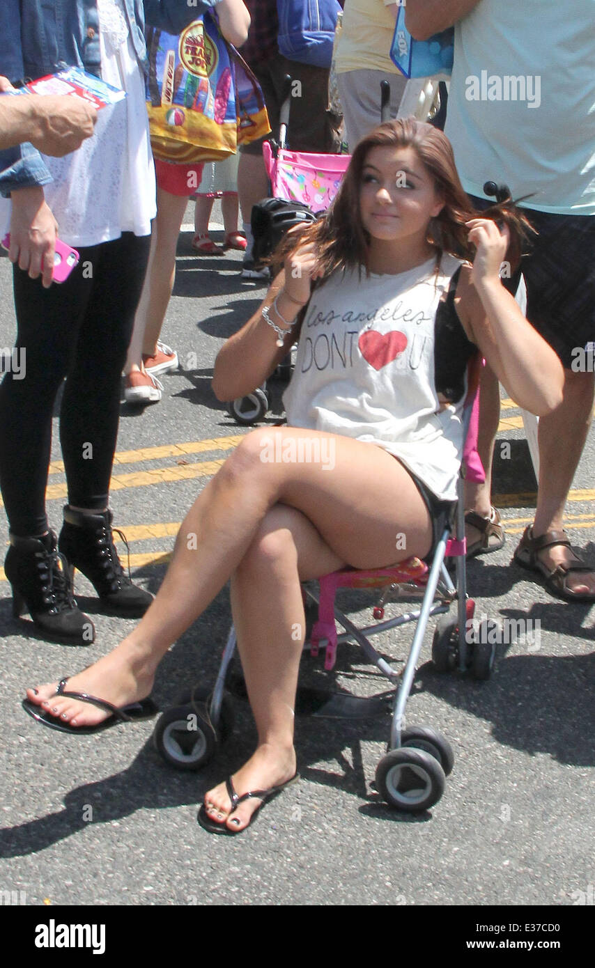 Ariel Winter takes a break to sit down in a stroller, as she enjoys a ...