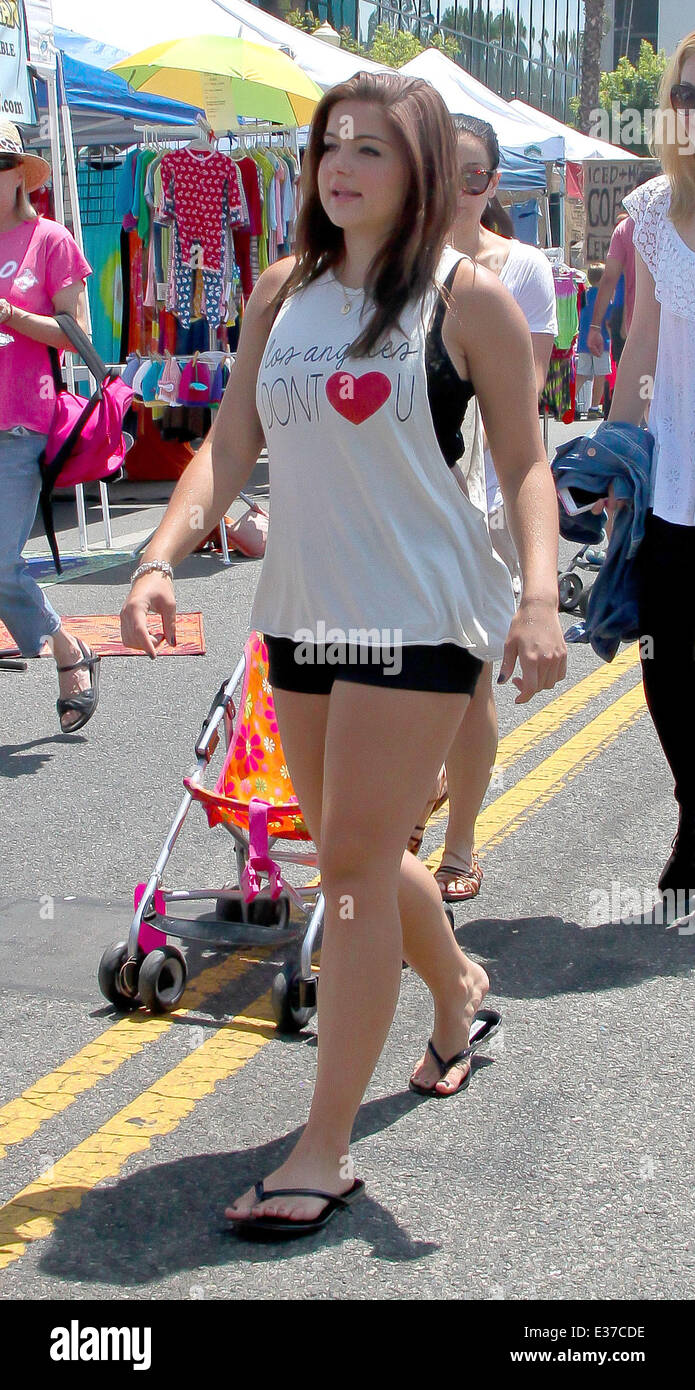 Ariel Winter takes a break to sit down in a stroller, as she enjoys a ...