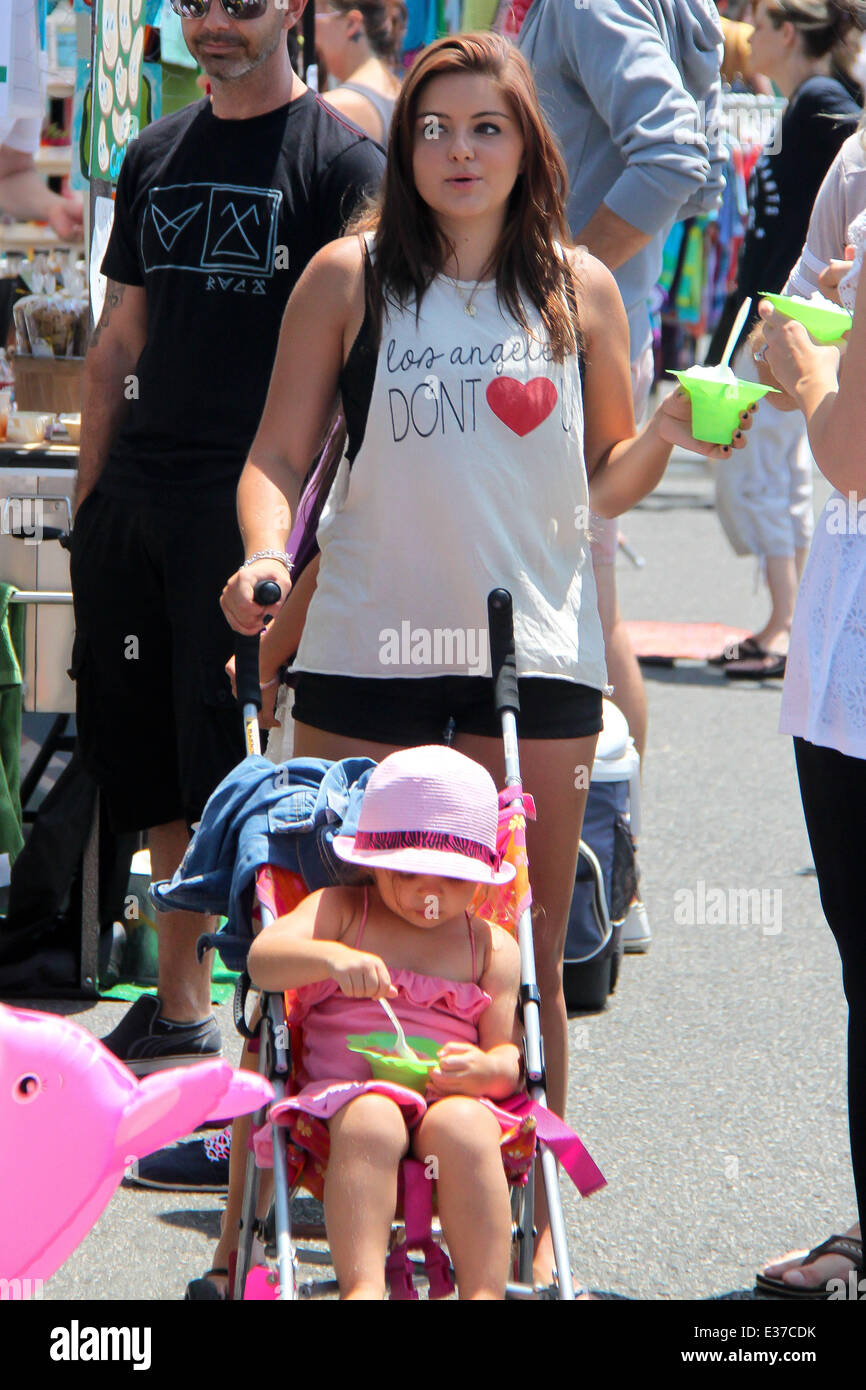 Ariel Winter takes a break to sit down in a stroller, as she enjoys a ...