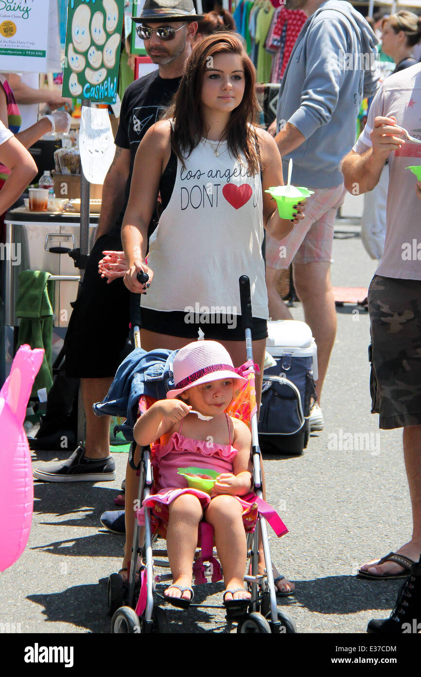 Ariel Winter takes a break to sit down in a stroller, as she enjoys a ...