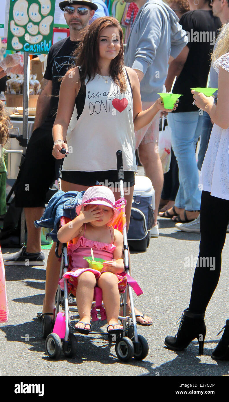 Ariel Winter takes a break to sit down in a stroller, as she enjoys a ...