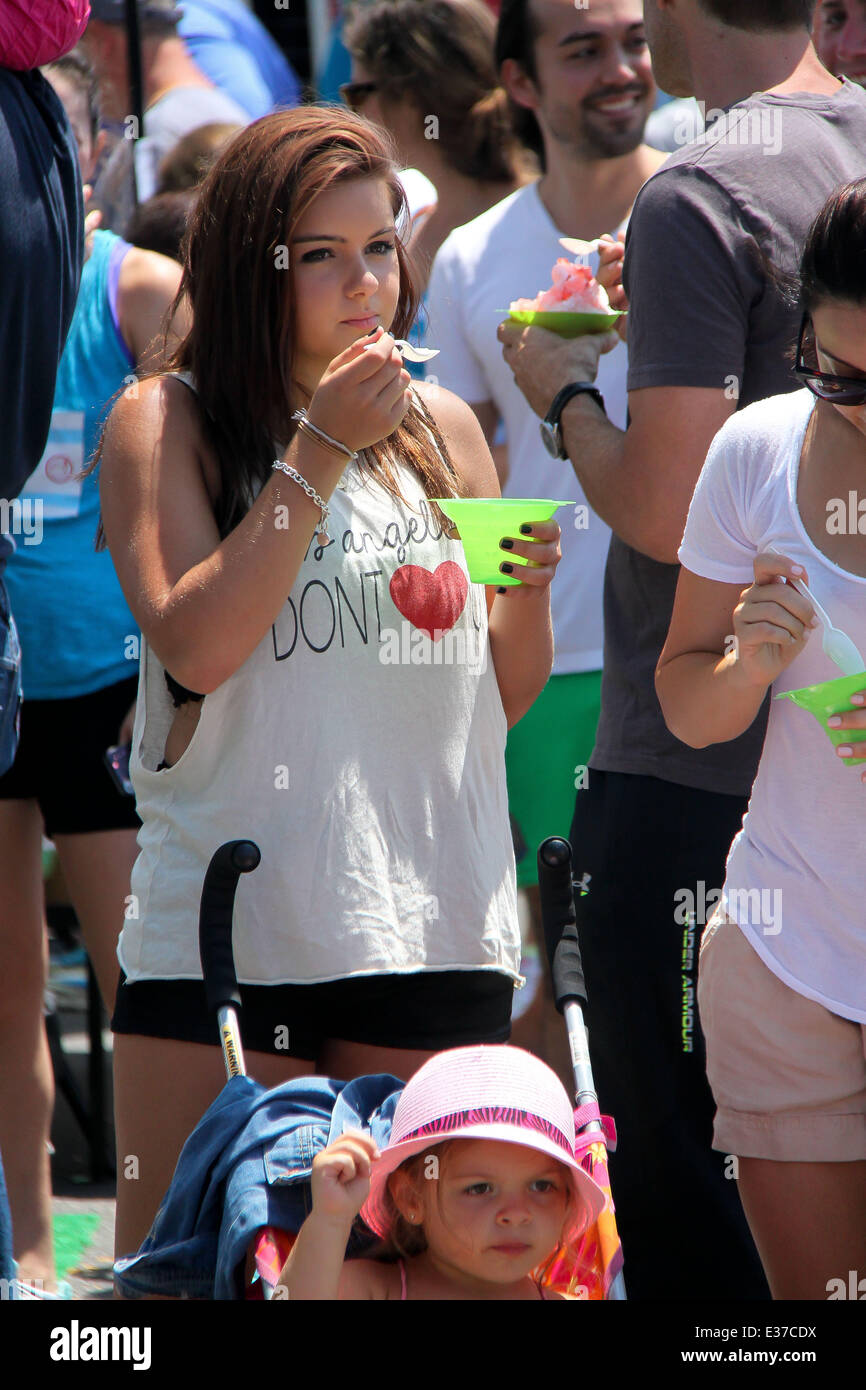 Ariel Winter takes a break to sit down in a stroller, as she enjoys a ...