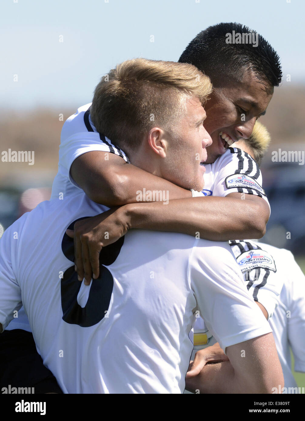 Usa. 21st June, 2014. SPORTS -- Luke Lawrence, 8, is embraced by ...