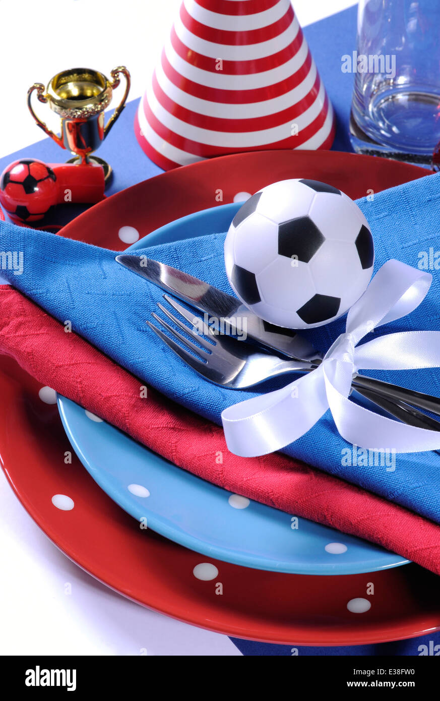 Soccer football party table setting with pates, cutlery, glasses ...