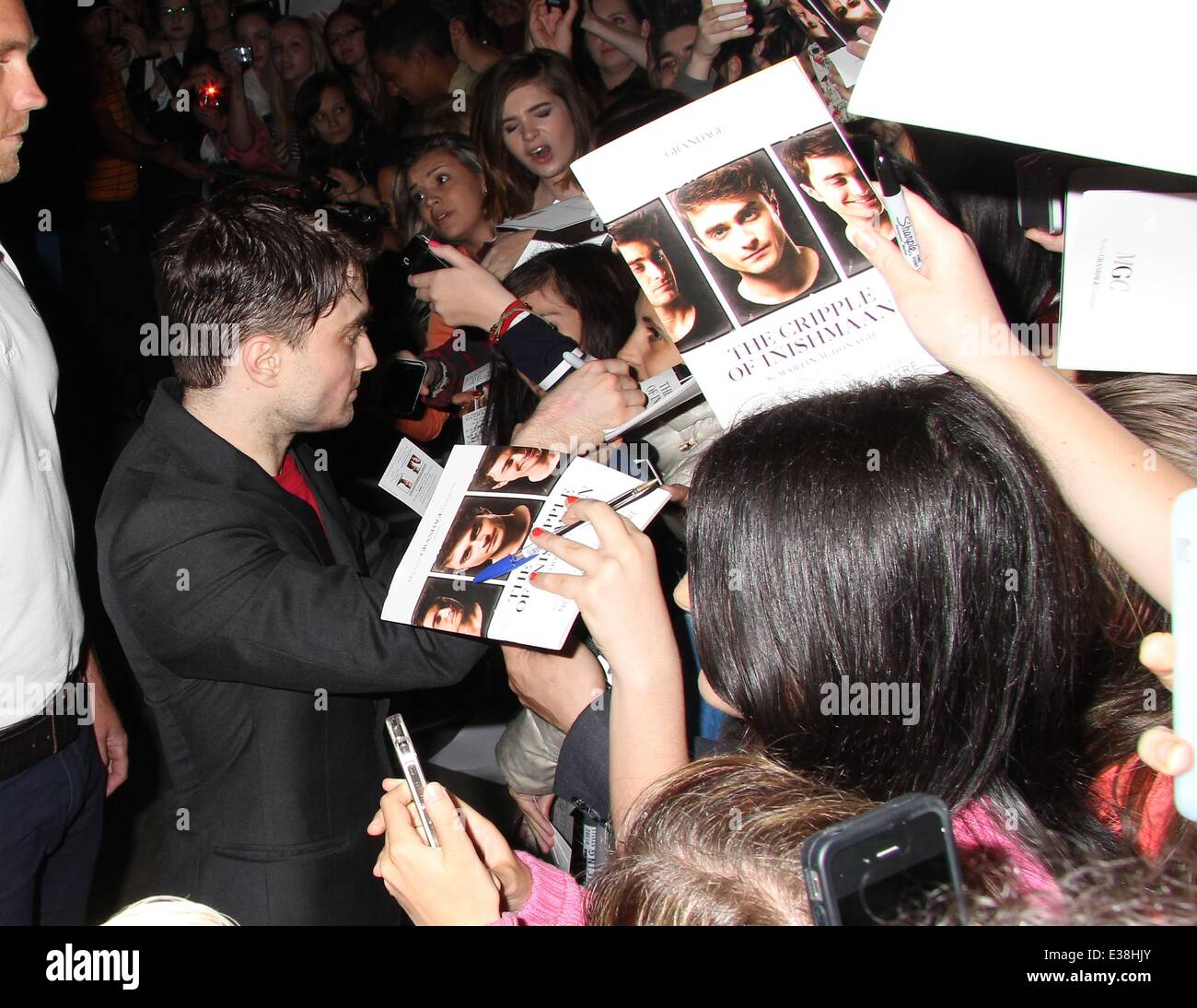 Daniel Radcliffe is greeted by hundreds of fans outside the stage door ...