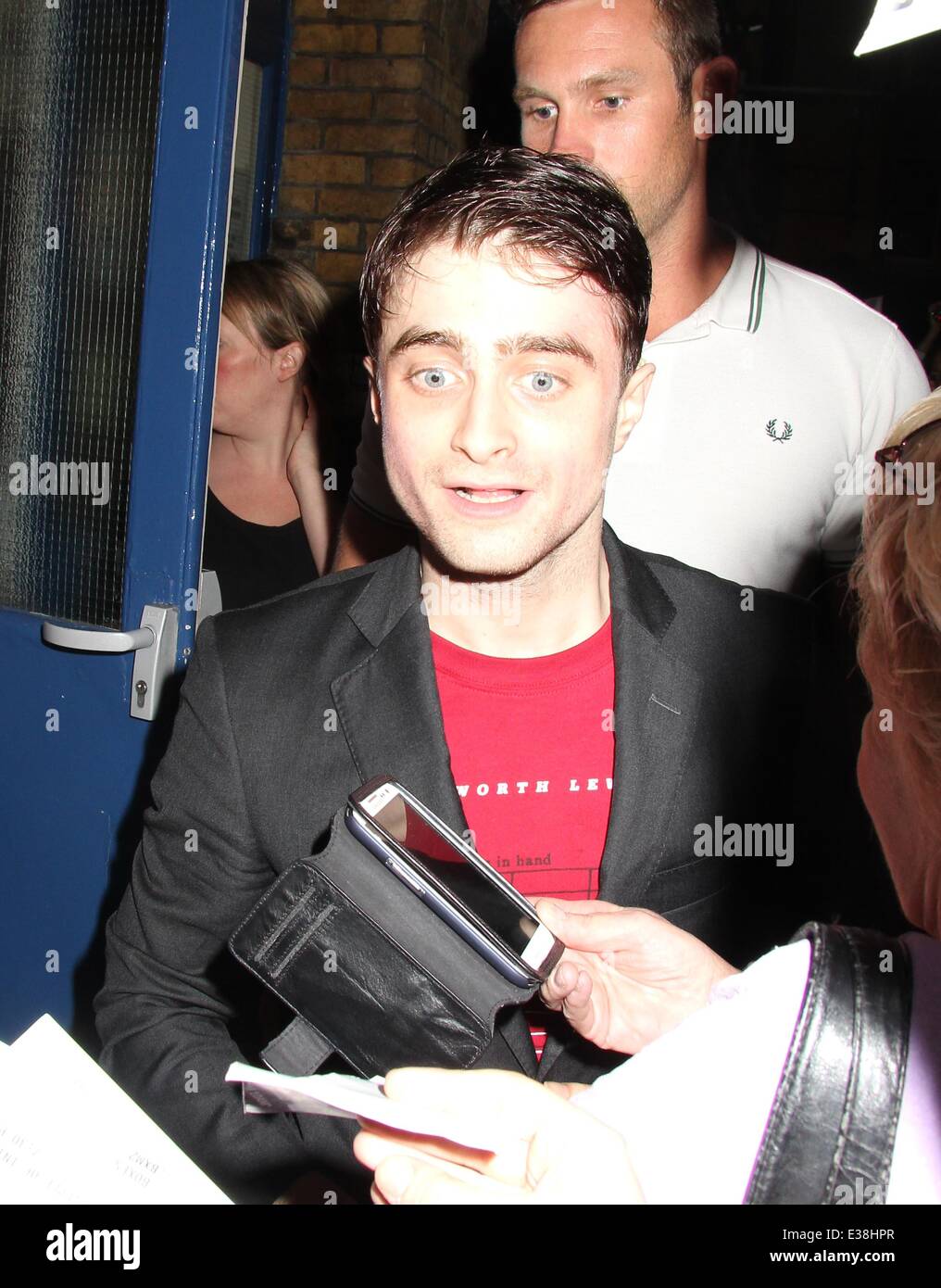 Daniel Radcliffe is greeted by hundreds of fans outside the stage door ...