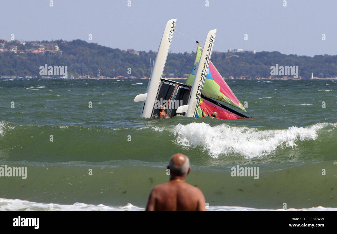 People watch at sinking catamaran yacht during a heavy wind storm at ...