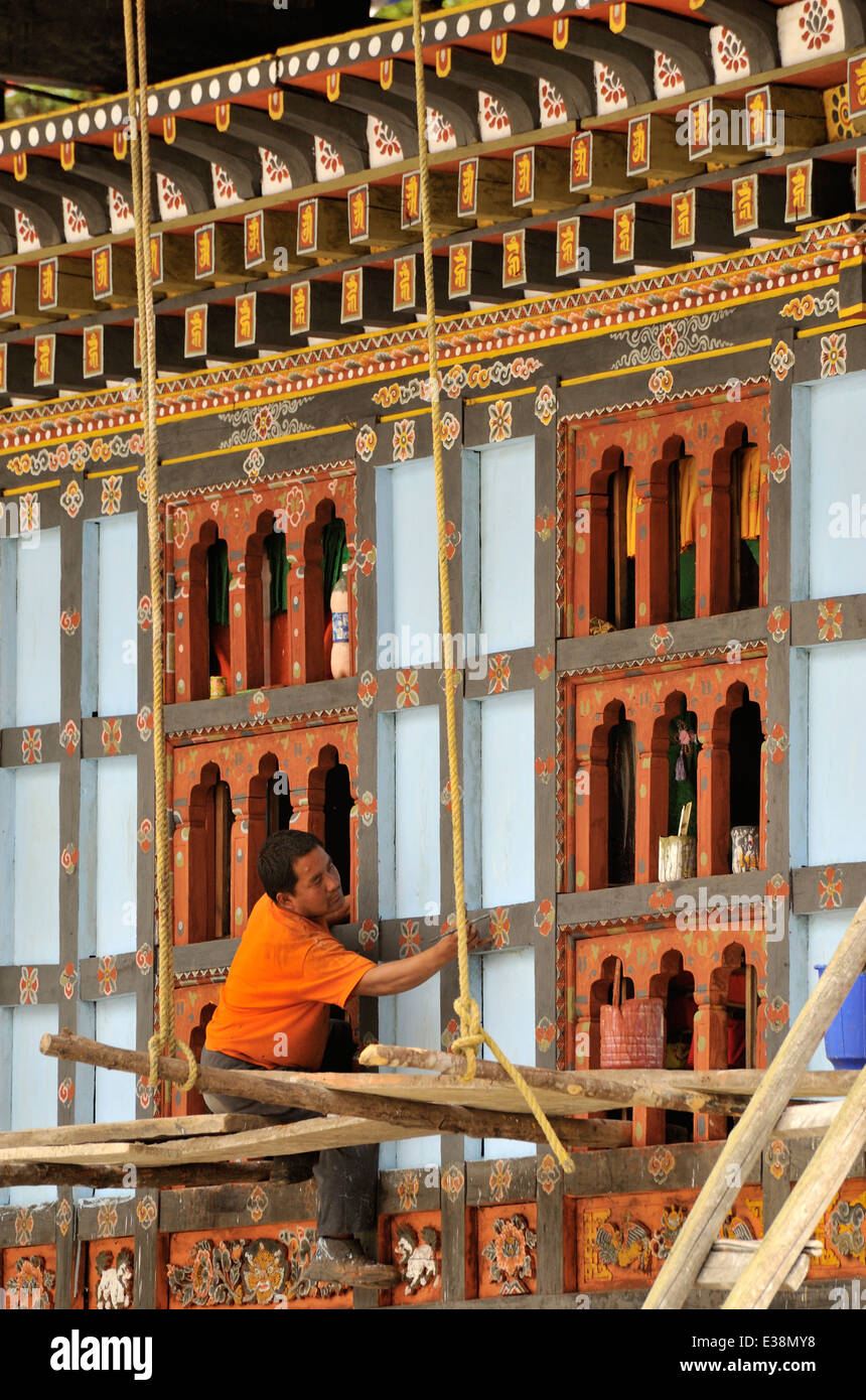 Man painting the facade of a traditional house, Trashiyangtse, Eastern ...
