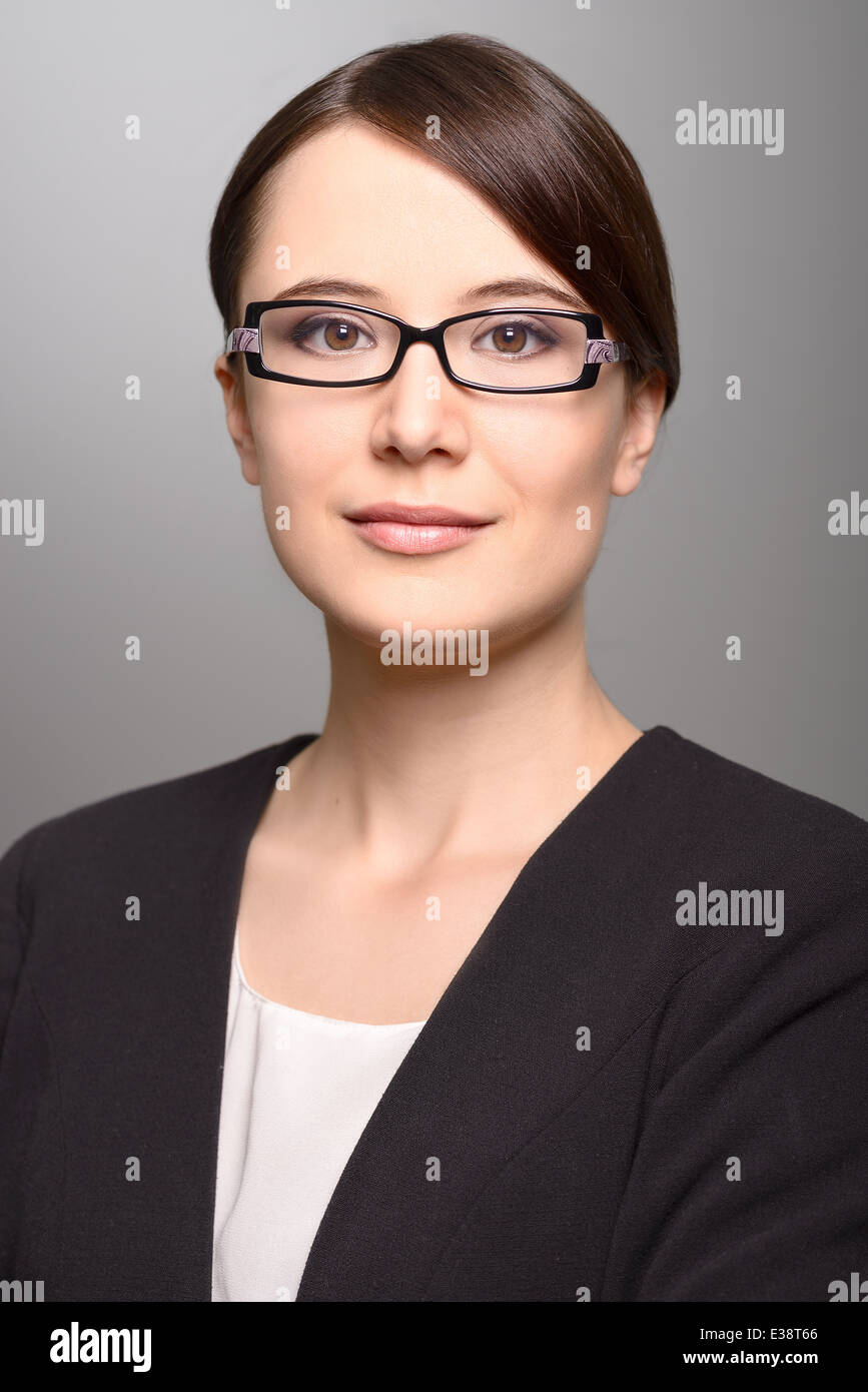 Businesswoman with an attentive expression wearing glasses Stock Photo ...