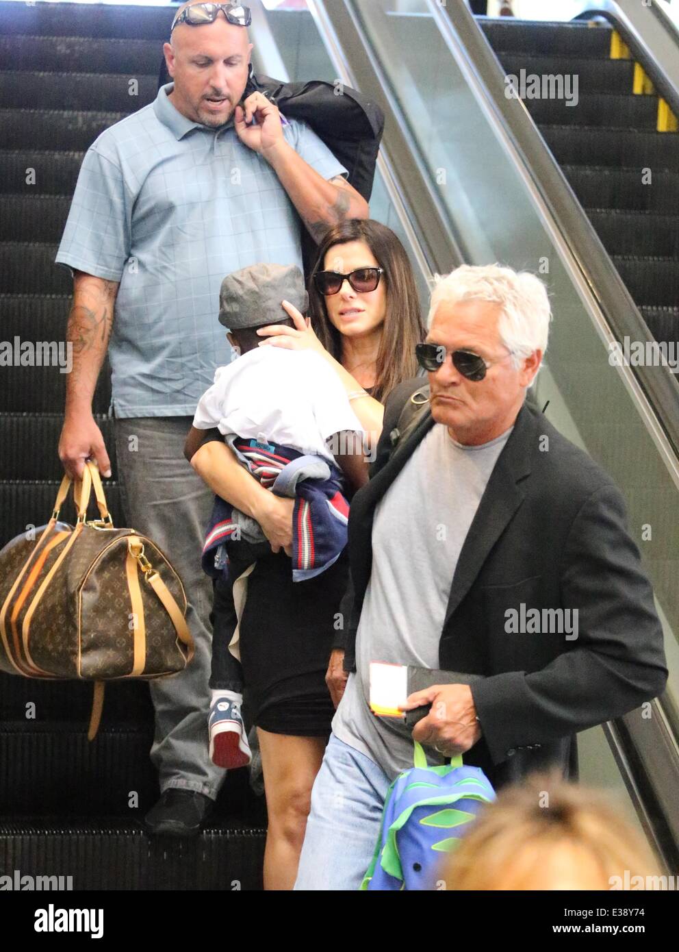 Sandra Bullock, along with her son Louis and a bodyguard, arrive at LAX ...