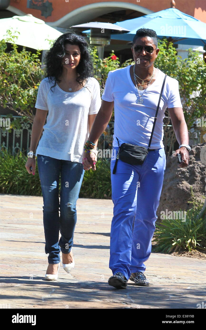 Jermaine Jackson walking holding hands with his wife Halima Rashid ...