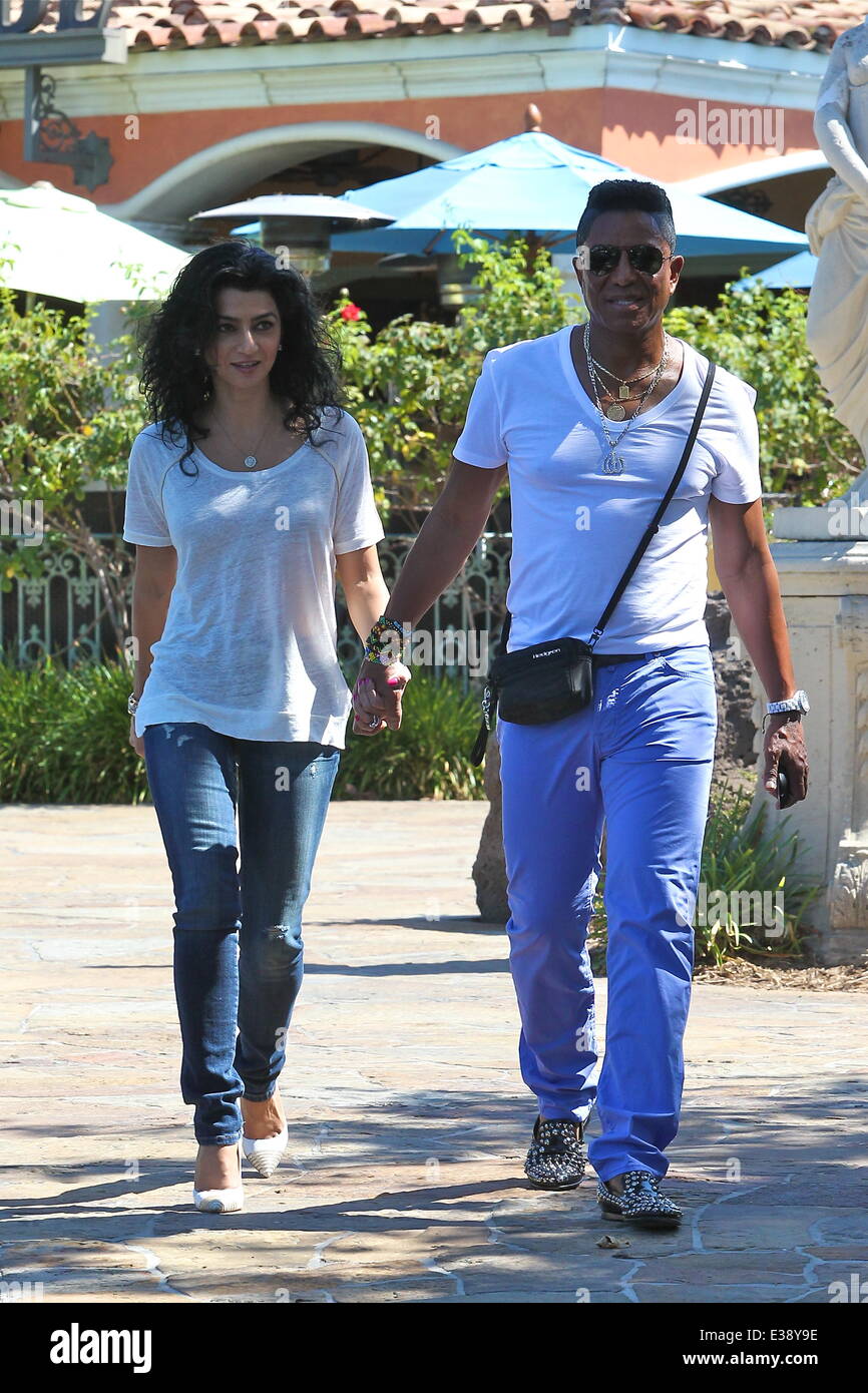 Jermaine Jackson walking holding hands with his wife Halima Rashid ...