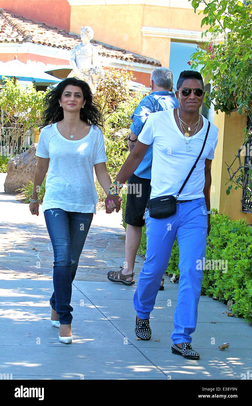 Jermaine Jackson walking holding hands with his wife Halima Rashid ...