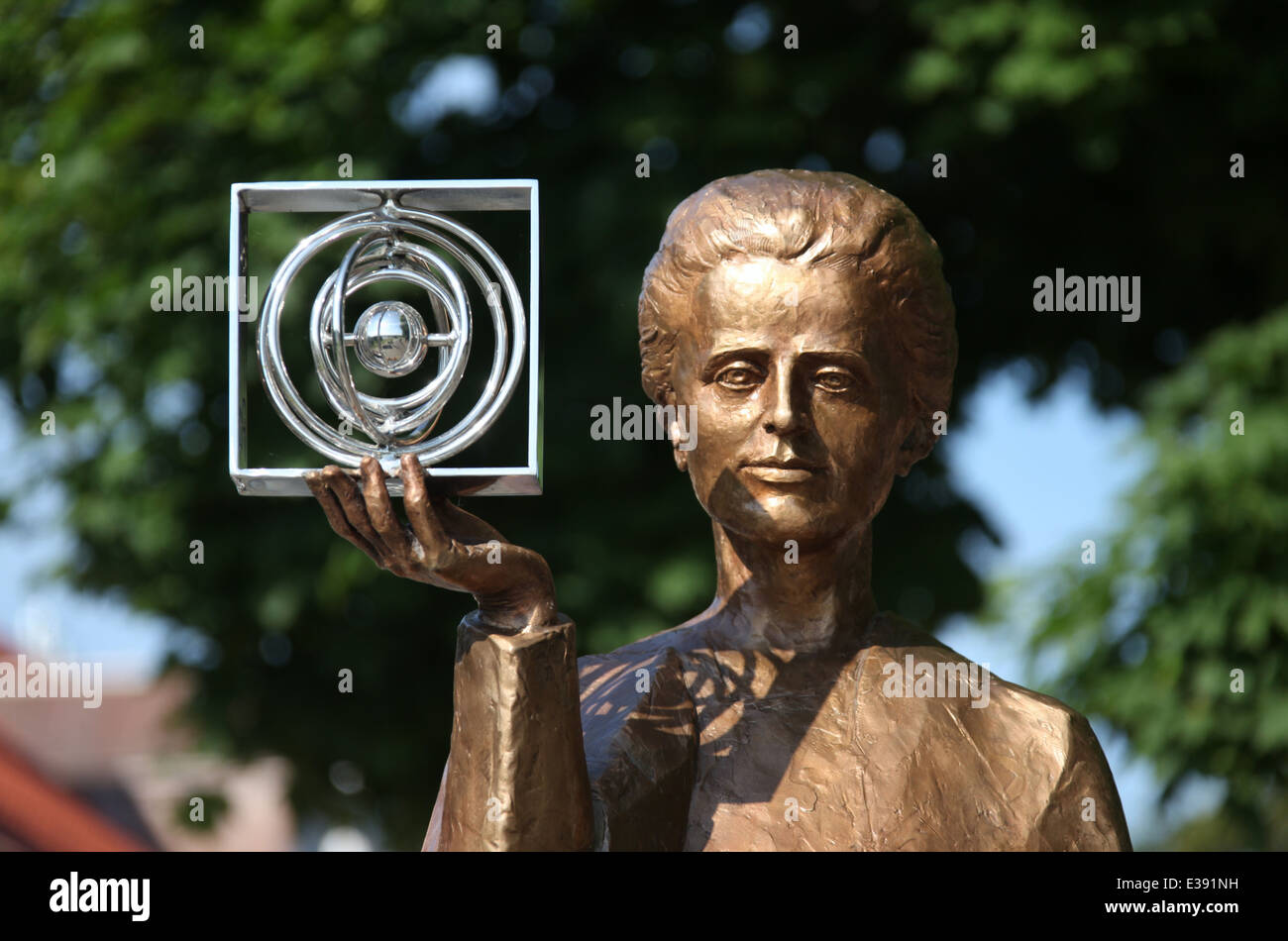 Statue of Maria Sklodowska Curie in Warsaw holding up a molecule of ...