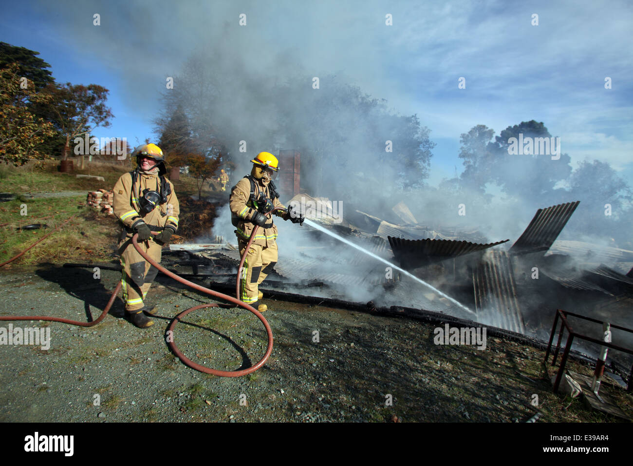 Firemen damping down a barn fire, Nelson, New Zealand Stock Photo - Alamy