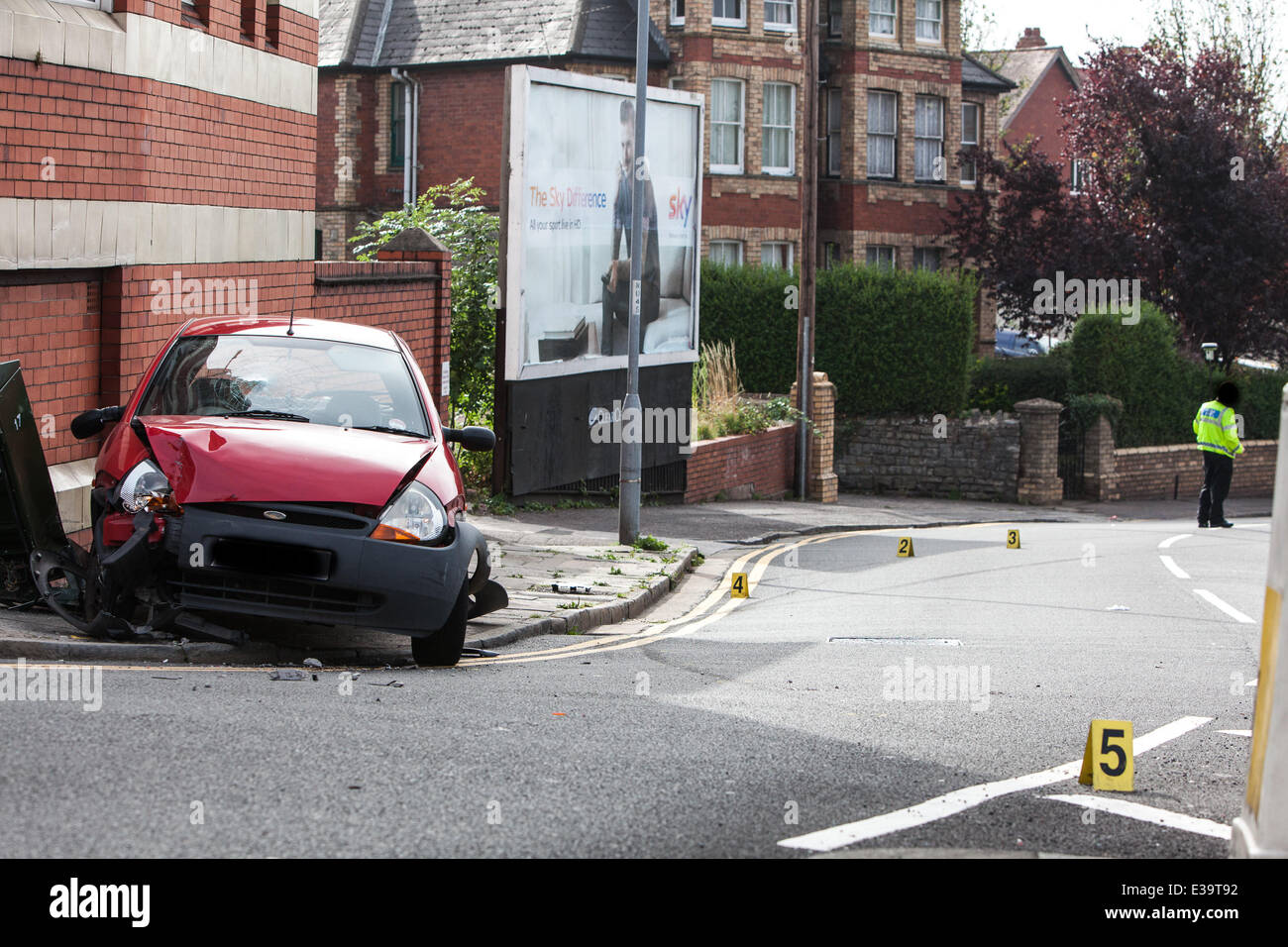 A red Ford KA can be seen crashed into a telecoms cabinet and three ...