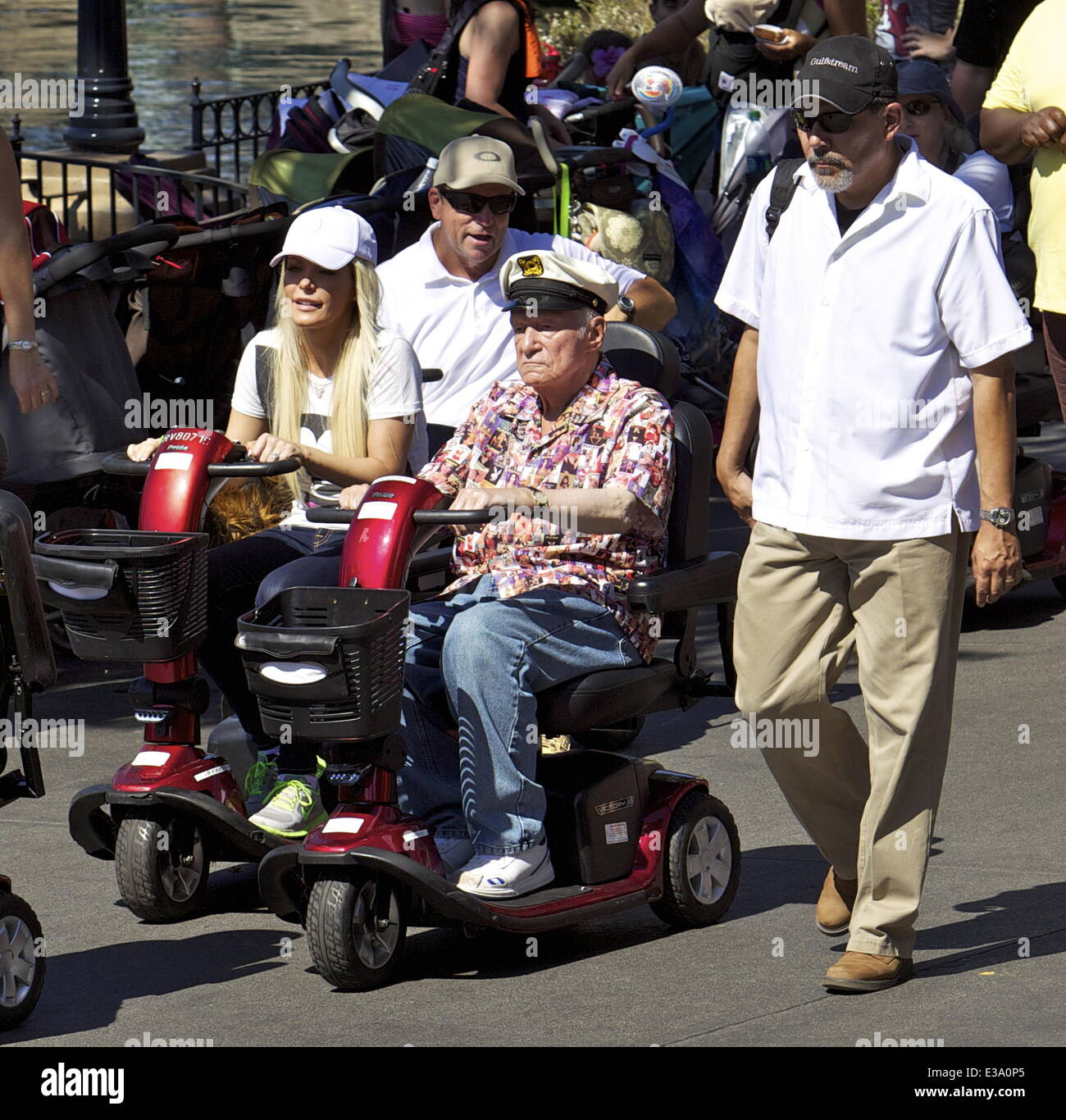 Hugh Hefner and Crystal Hefner ride mobility scooters through ...