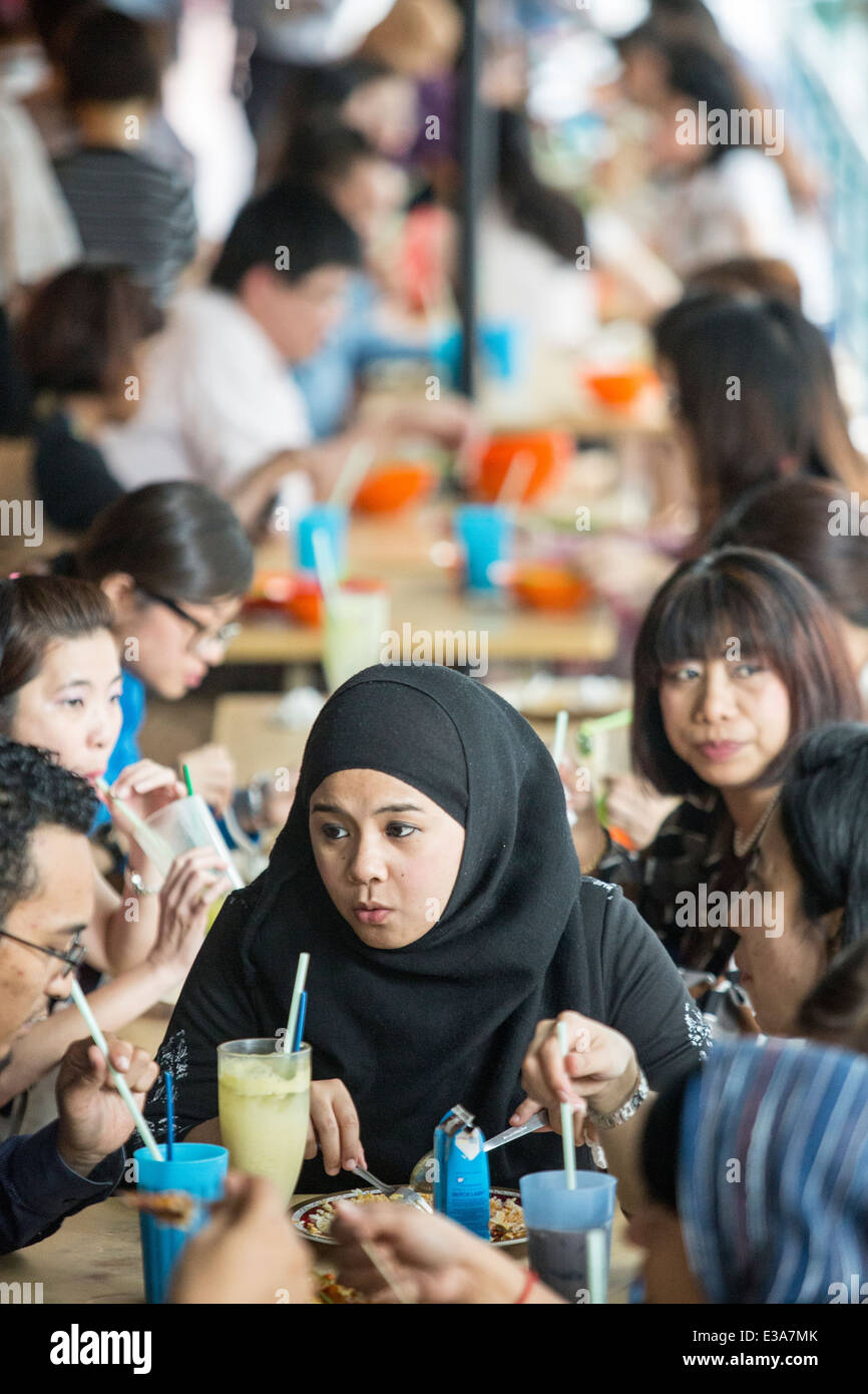 Office workers eat lunch in a hawker center in Kuala Lumpur, Malaysia ...