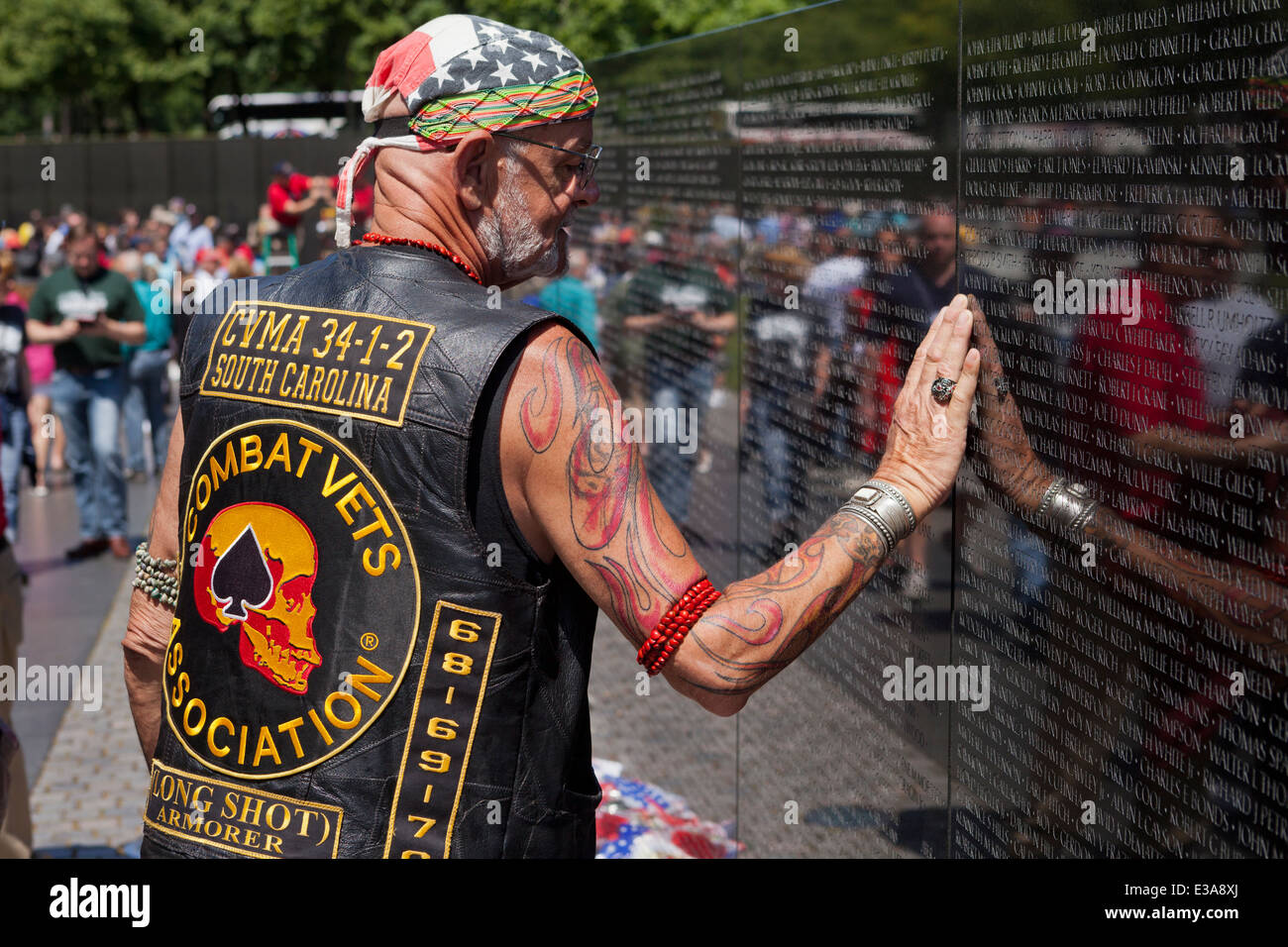 Veteran touching the wall of inscribed names of fallen solders at the ...