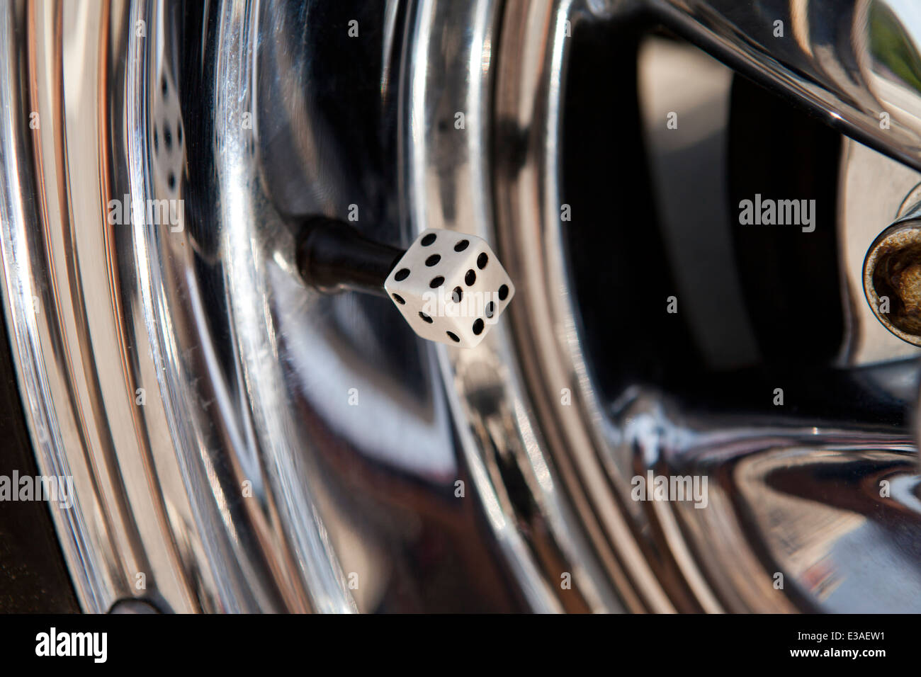 Dice tire valve cover on chrome rim Stock Photo - Alamy