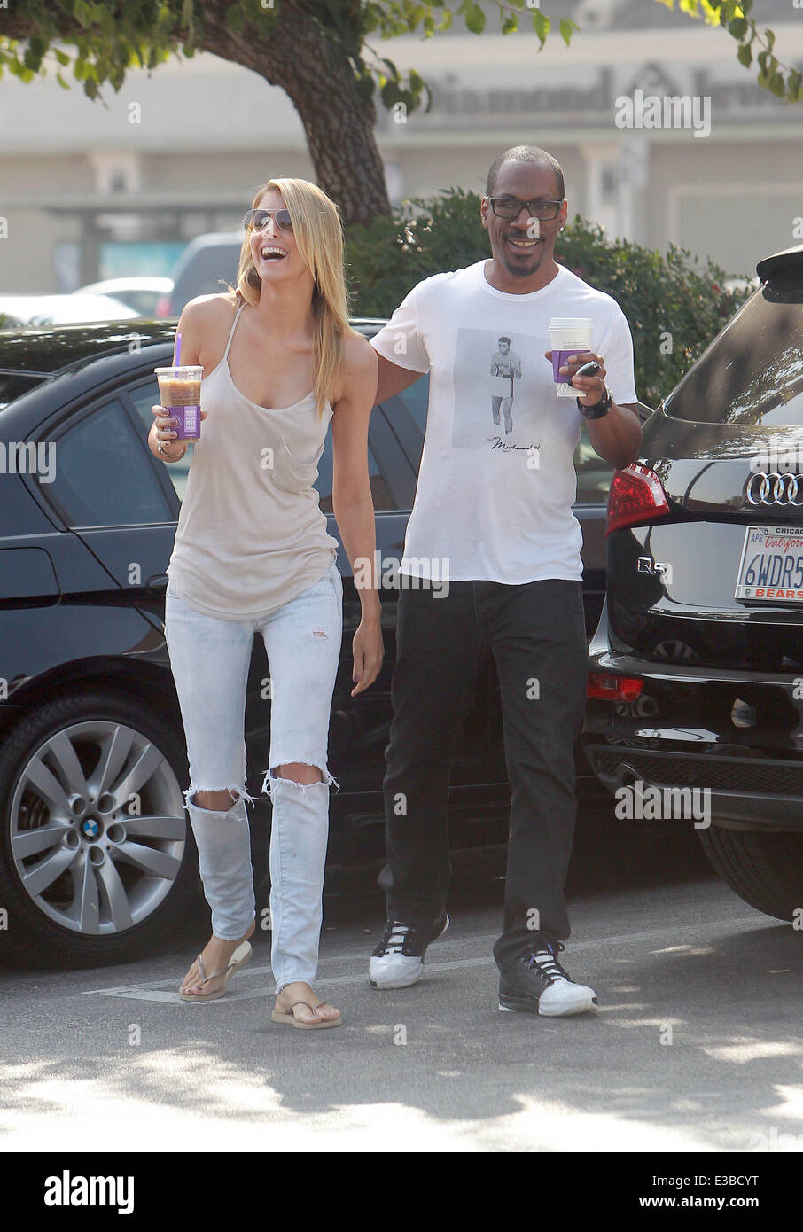 Eddie Murphy laughs as he is handed a rose by two cross-dressers in Los ...