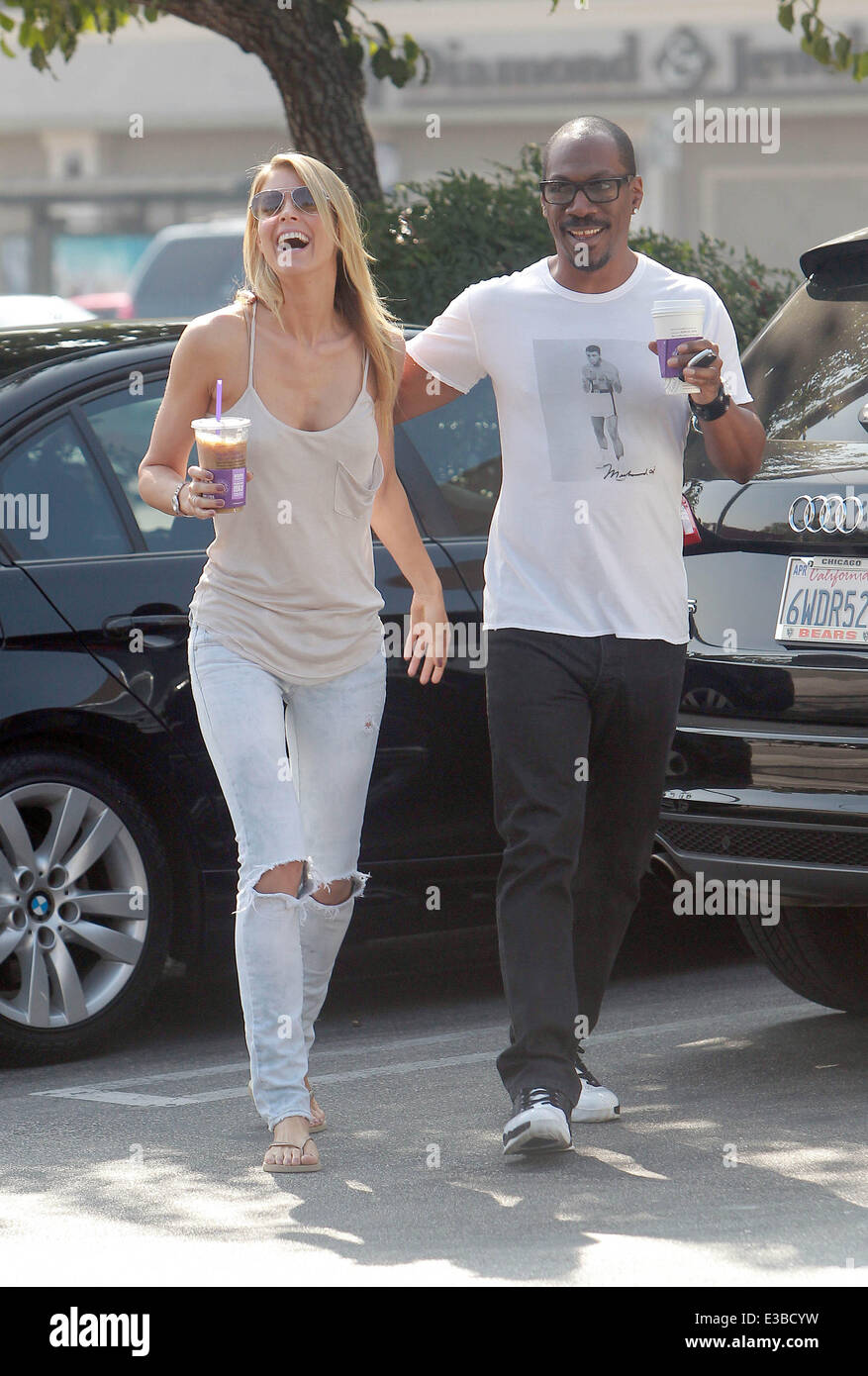 Eddie Murphy laughs as he is handed a rose by two cross-dressers in Los ...