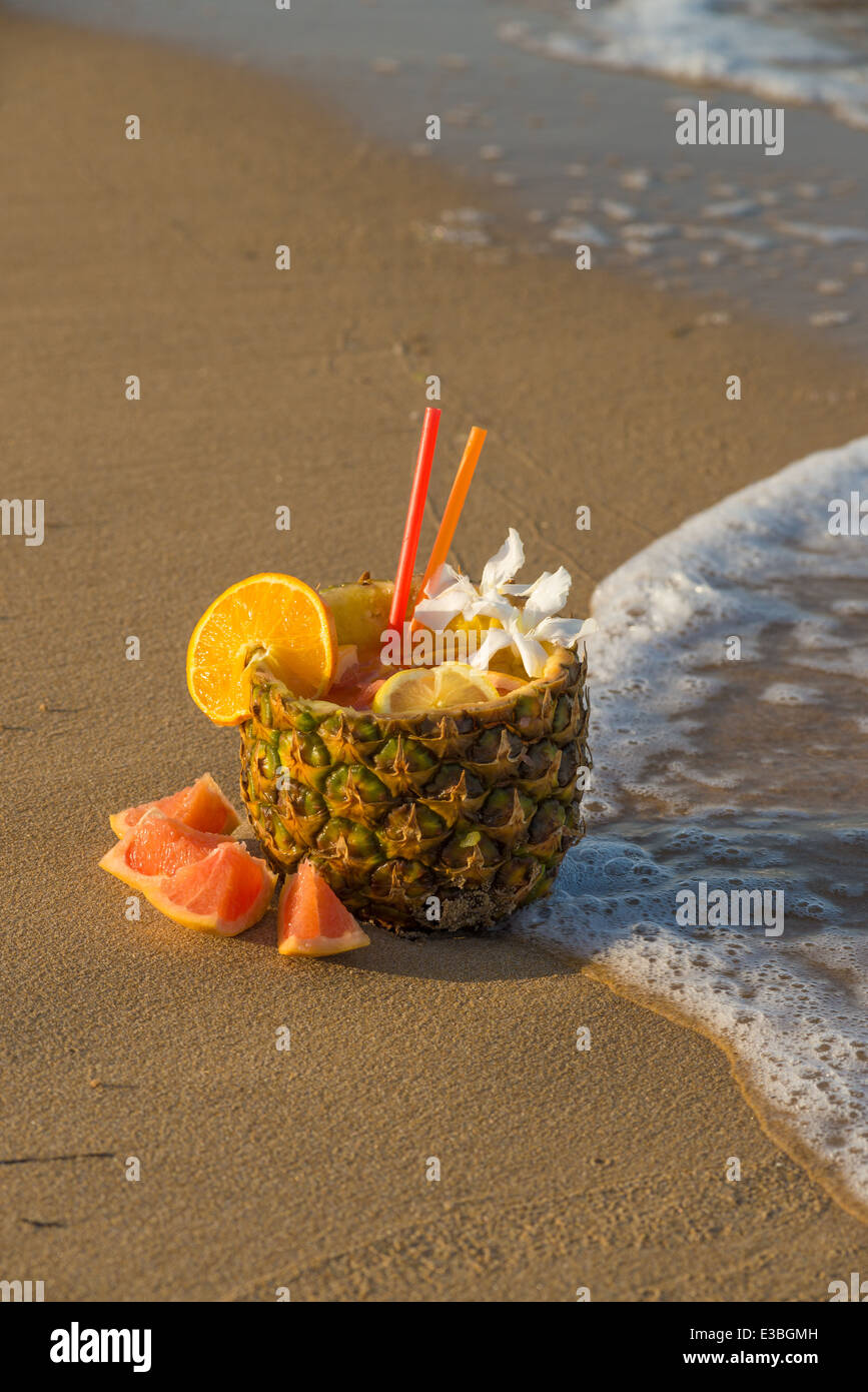 Fruity drink served inside a pineapple shell Stock Photo - Alamy