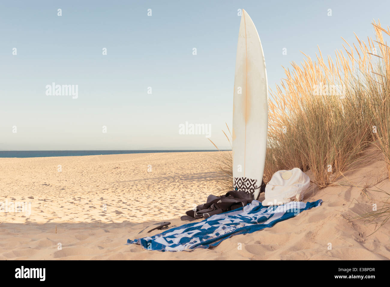 Surf board, towel and beach scene. Tarifa, Costa de la Luz, Cadiz ...