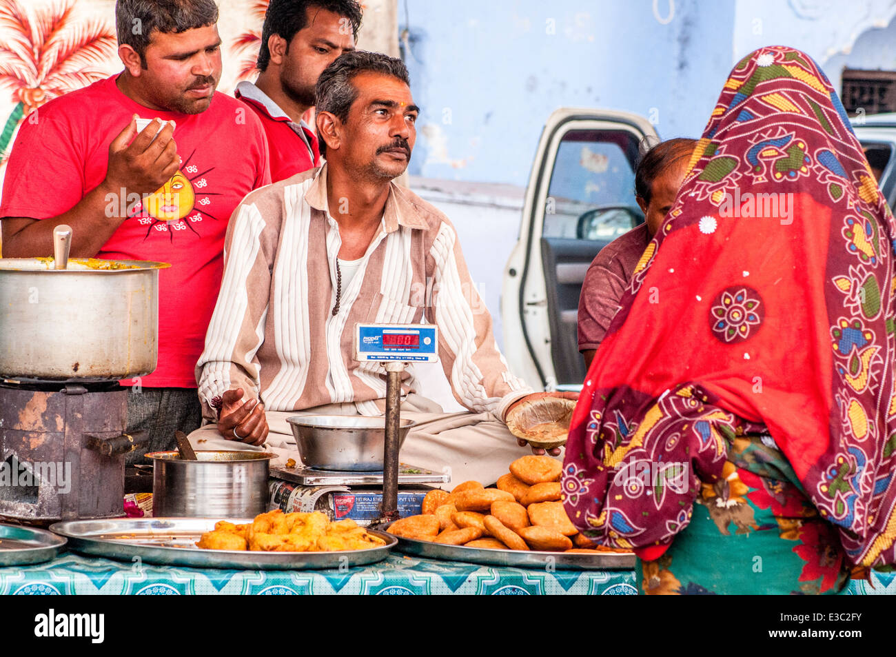 Street vendor sells Indian food off a street stall. Photographed in ...